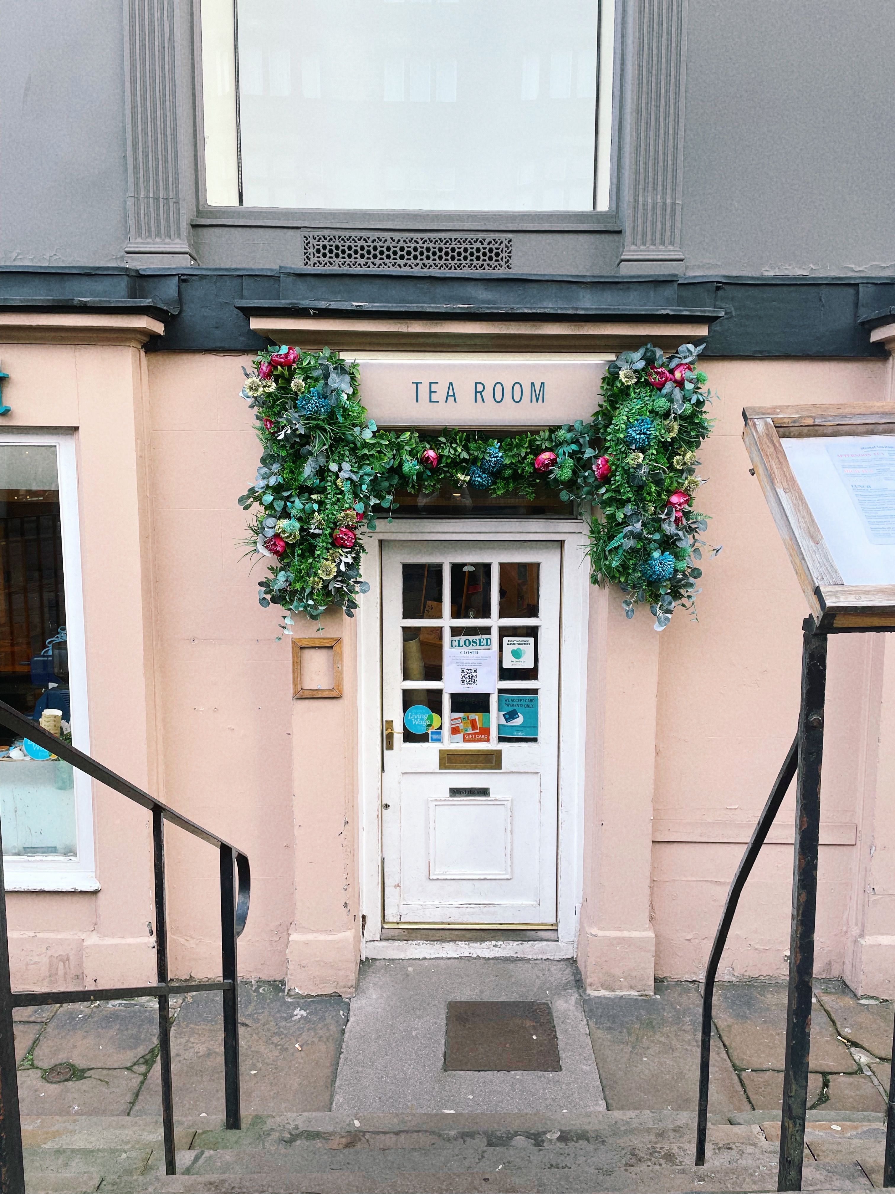 Charming Tea Room Entrance with Floral Decor · Free Stock Photo