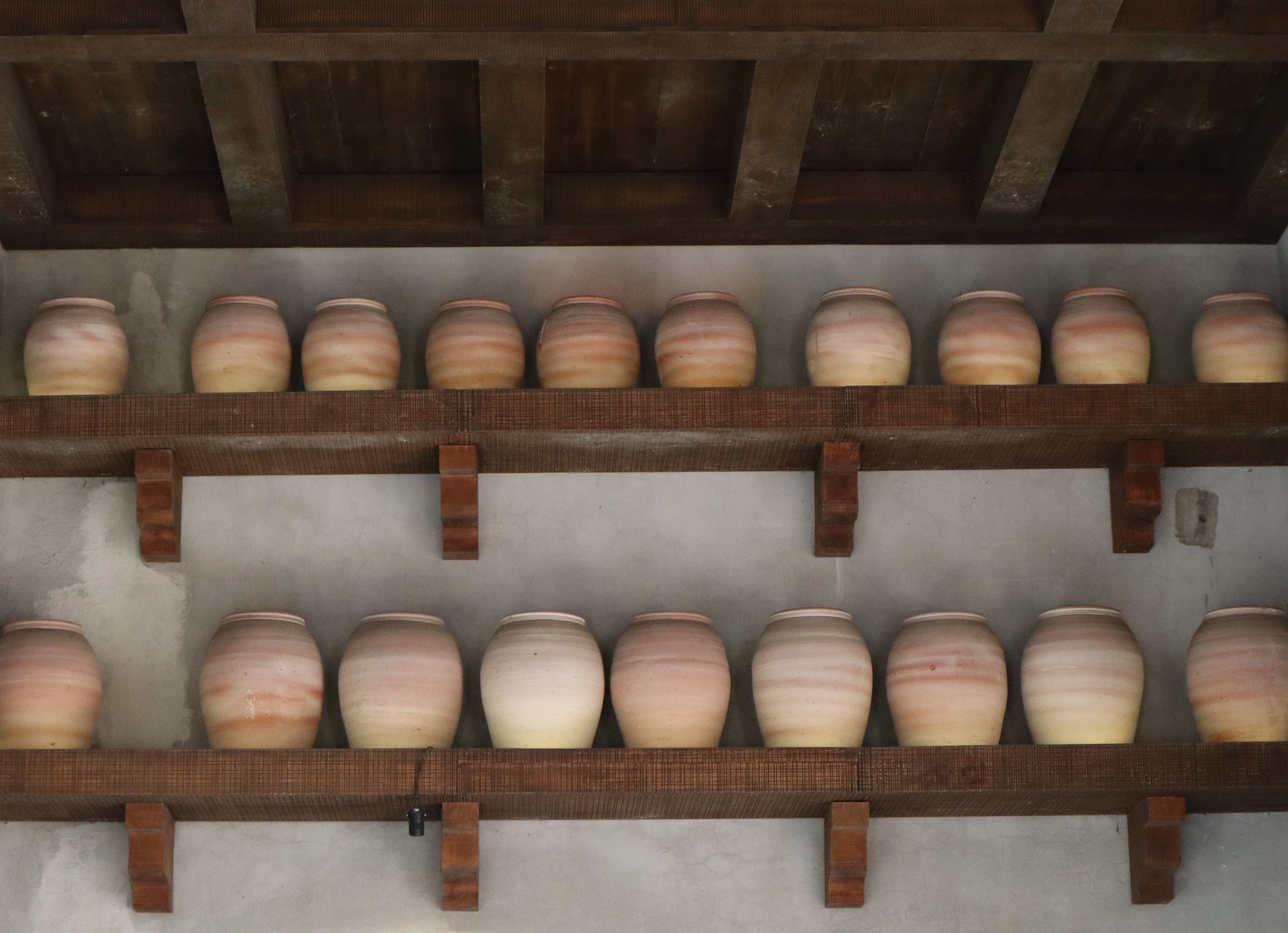Traditional Pottery Jars on Rustic Wooden Shelves · Free Stock Photo