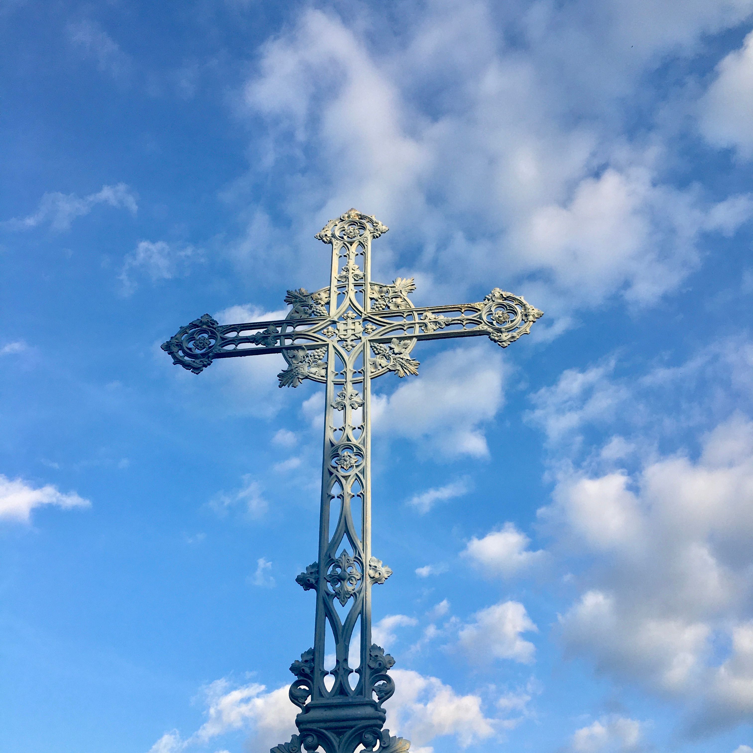 Ornate Metal Cross Against Blue Sky · Free Stock Photo