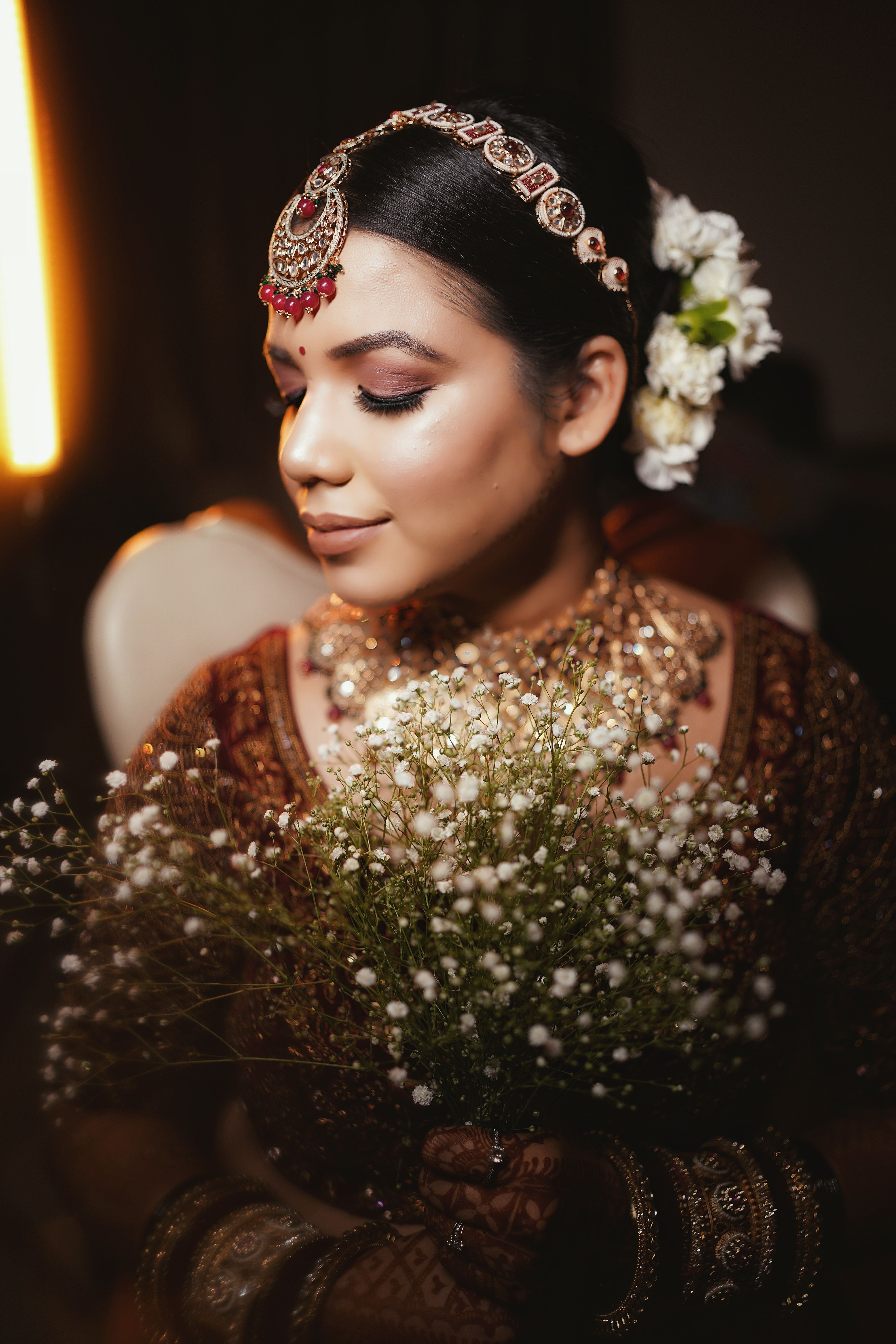 Elegant Indian Bride Holding Floral Bouquet · Free Stock Photo