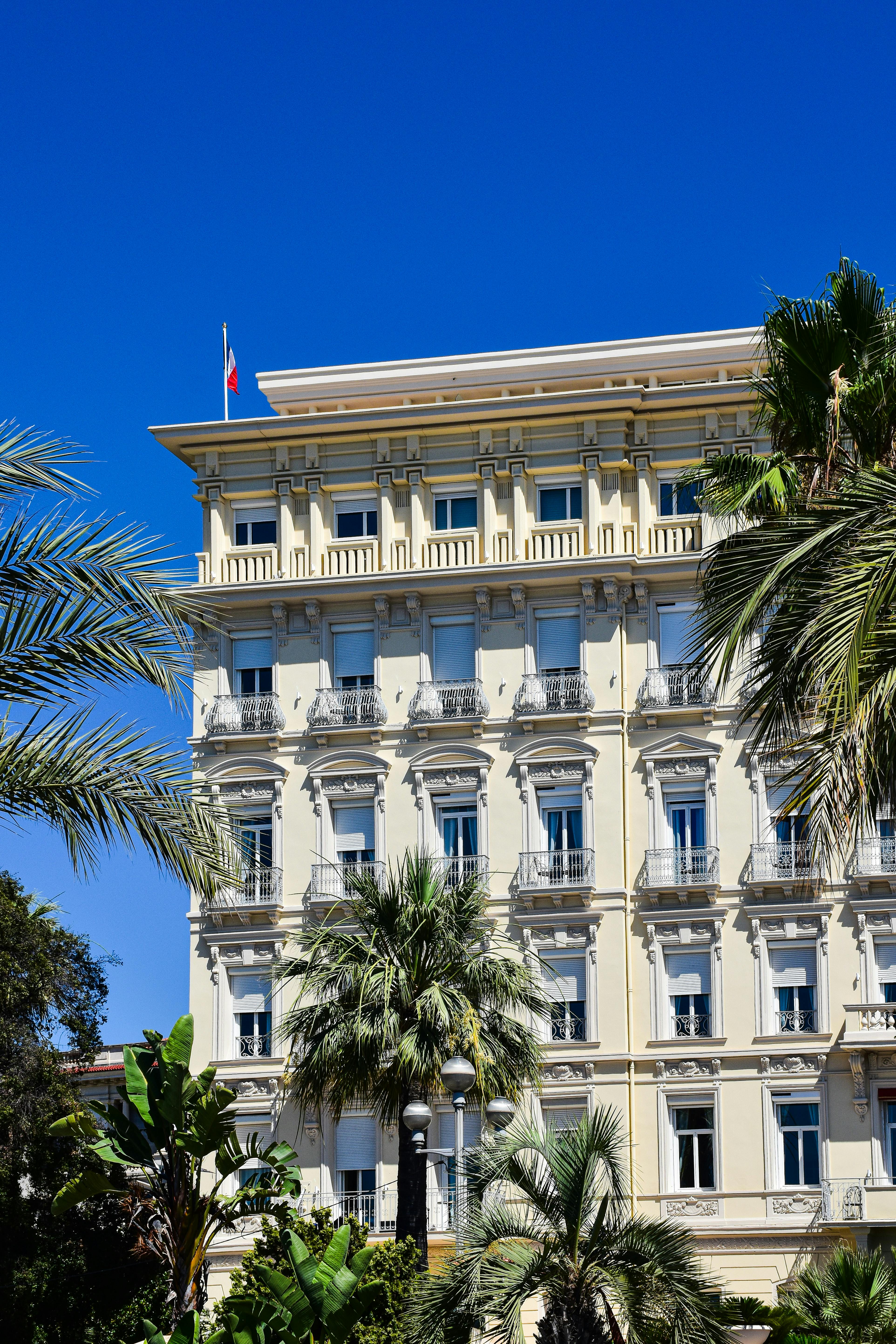 Elegant French Riviera Building with Palm Trees · Free Stock Photo