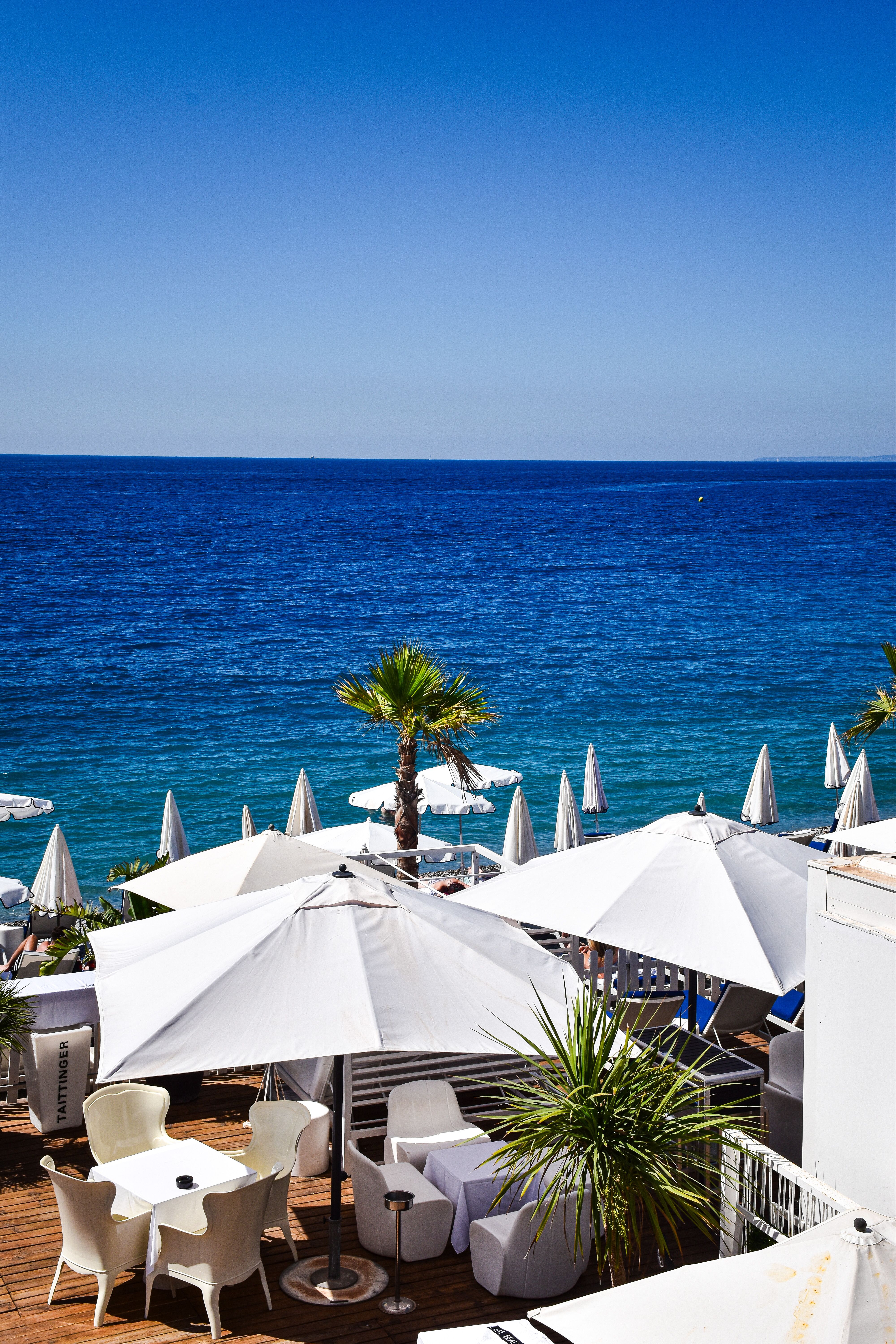 Scenic seaside view of French Riviera with umbrellas · Free Stock Photo