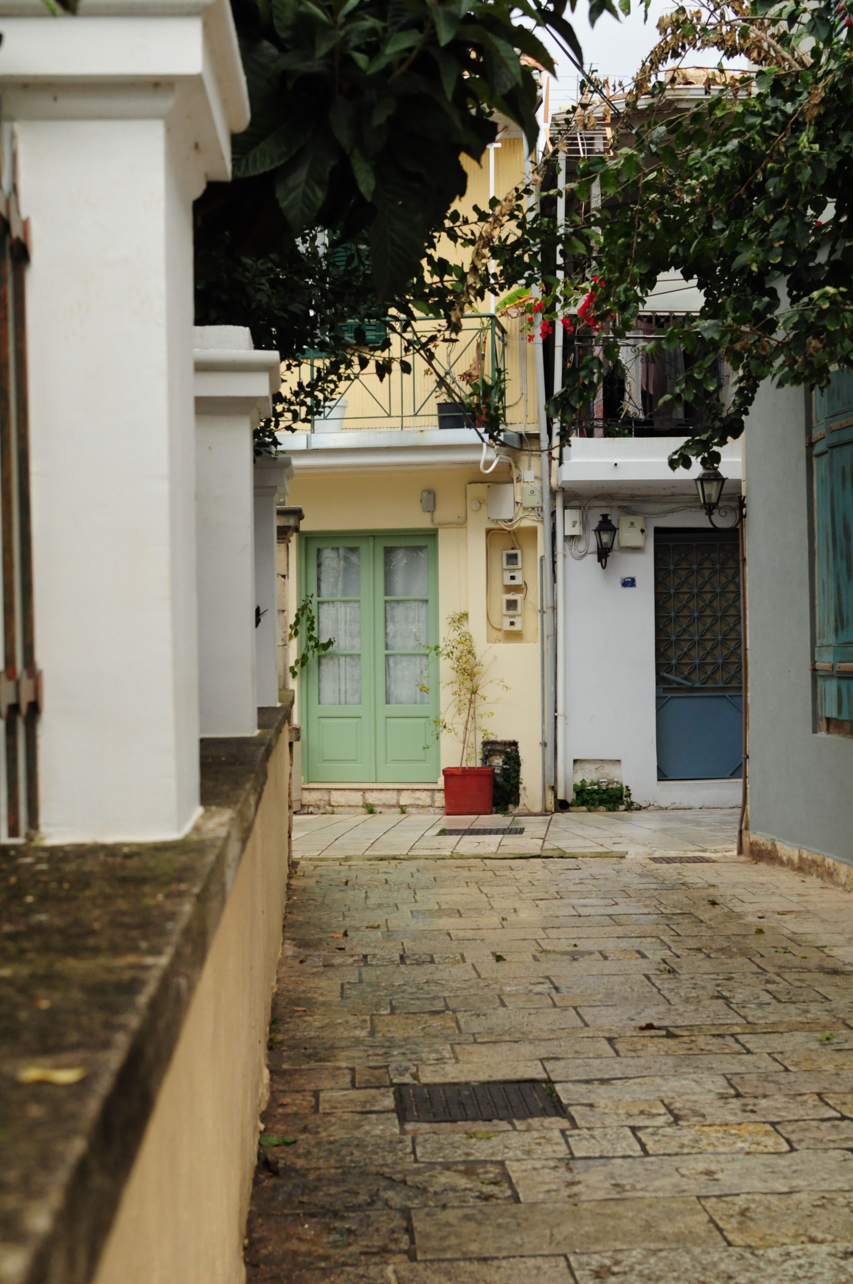 Charming Alleyway with Colorful Doors in Quaint Village · Free Stock Photo