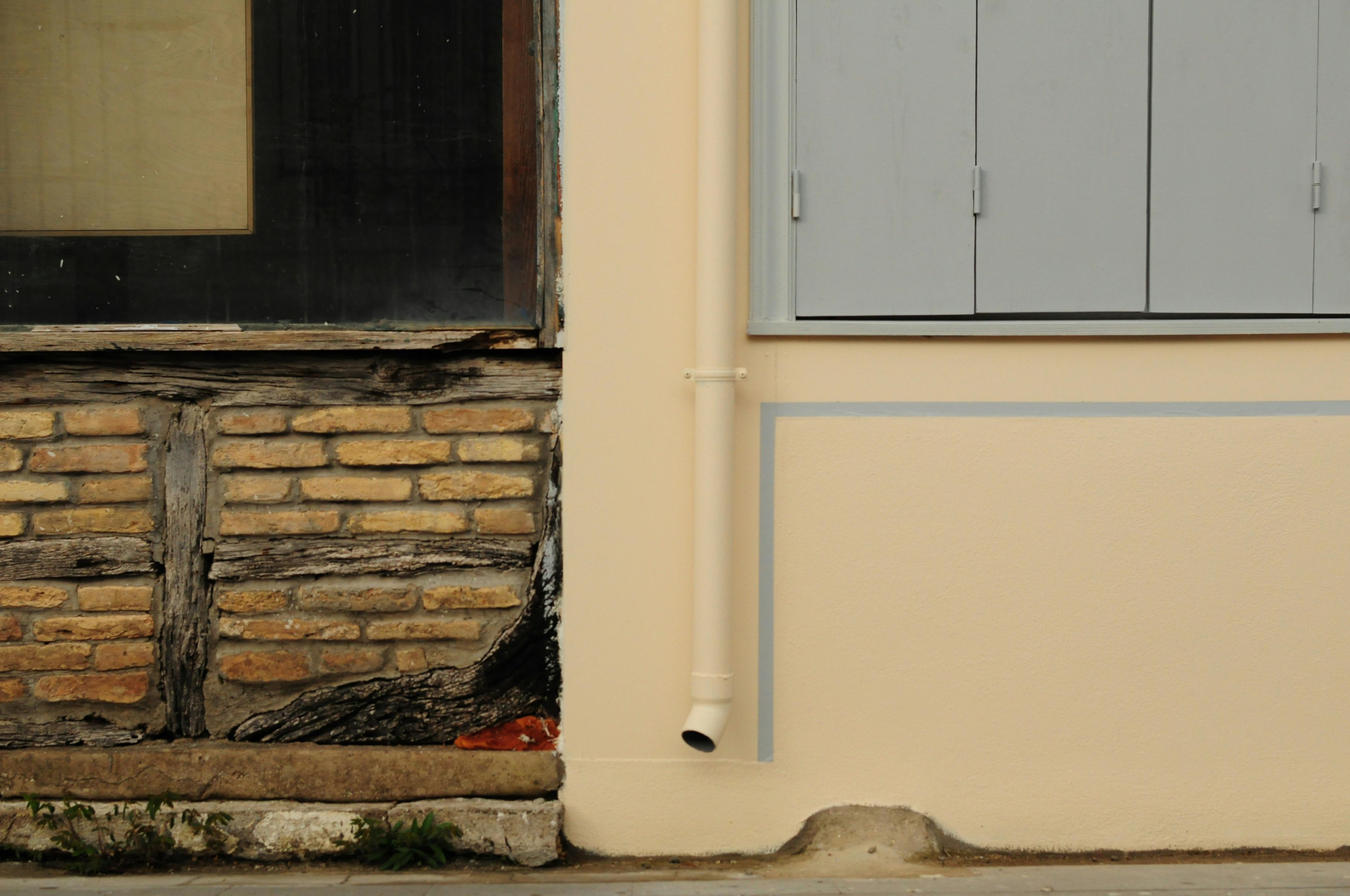 Textured Wall with Pipe and Window Shutters · Free Stock Photo