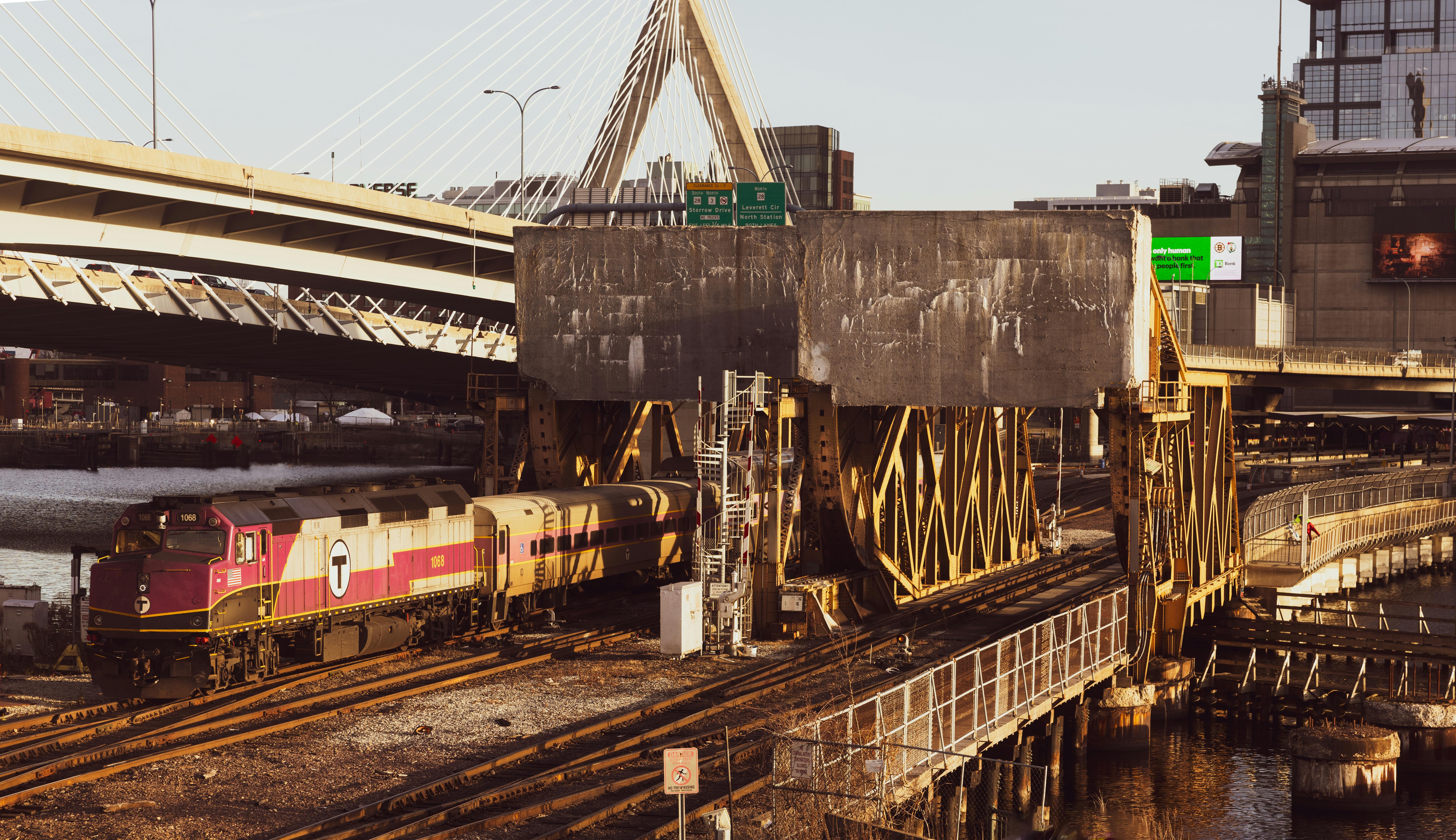 Boston Train Passing Under Zakim Bridge at Sunset · Free Stock Photo