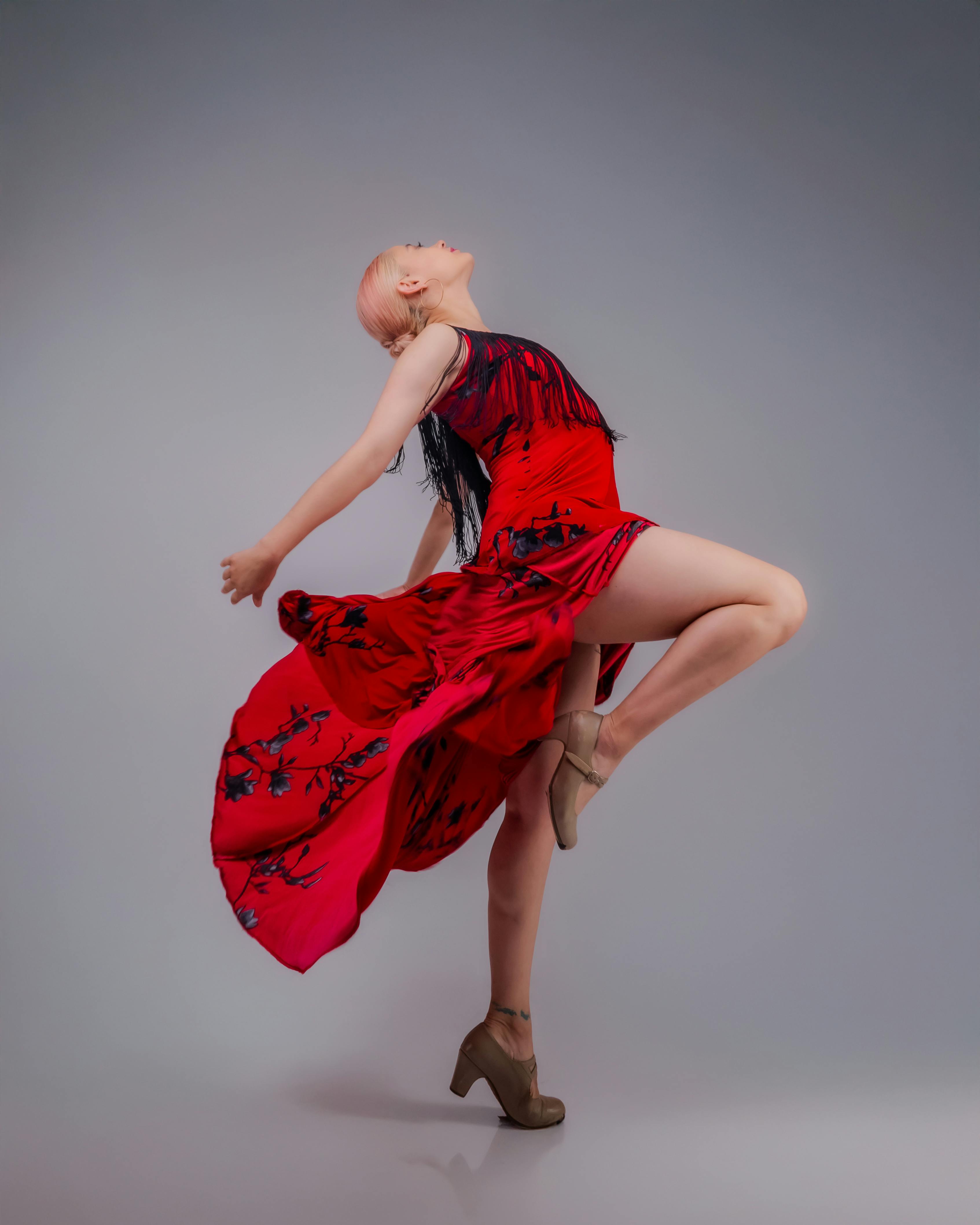 Dynamic Female Dancer in Red Dress Captured Mid-Motion · Free Stock Photo
