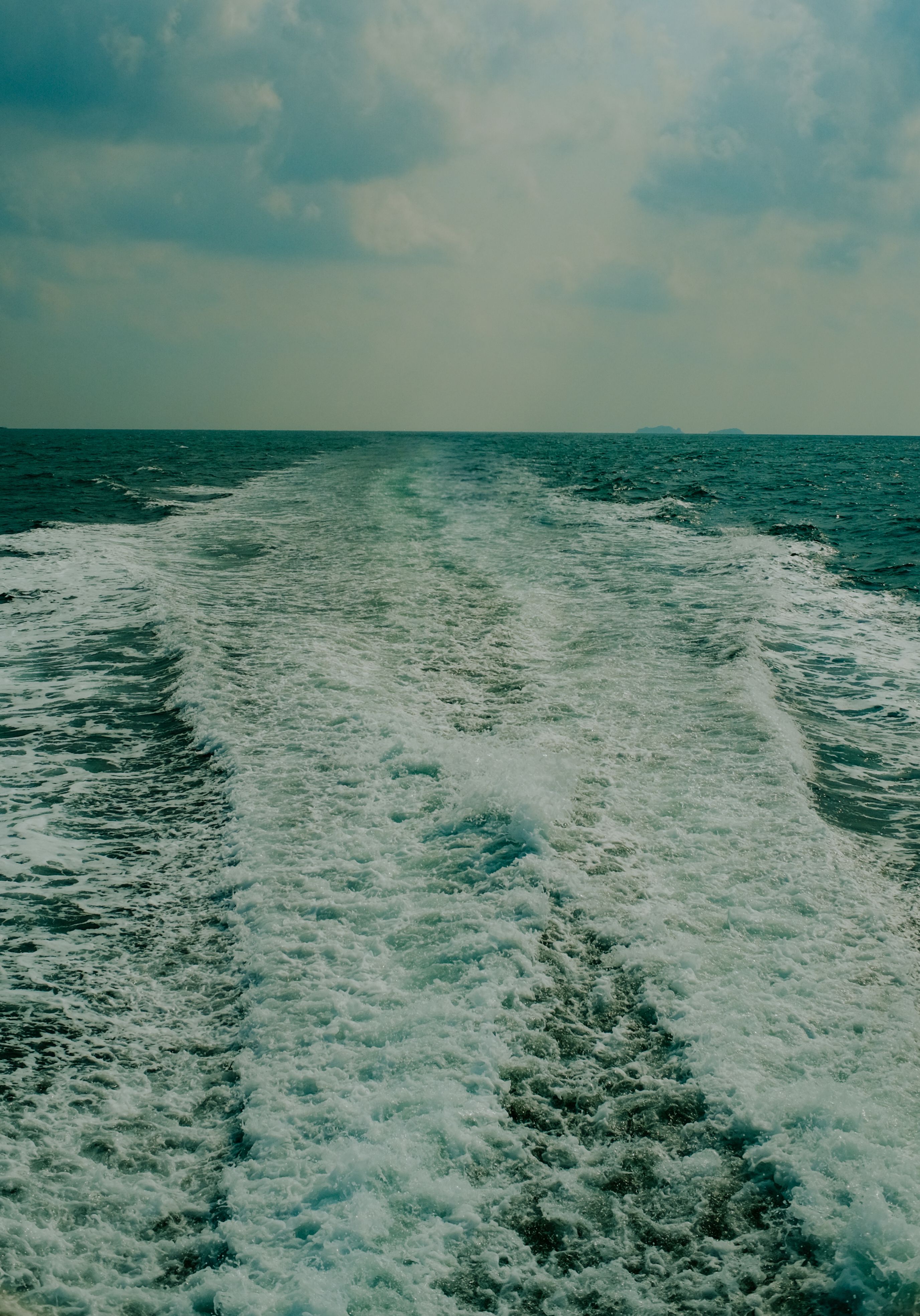 Serene Ocean Wake Under Cloudy Sky · Free Stock Photo