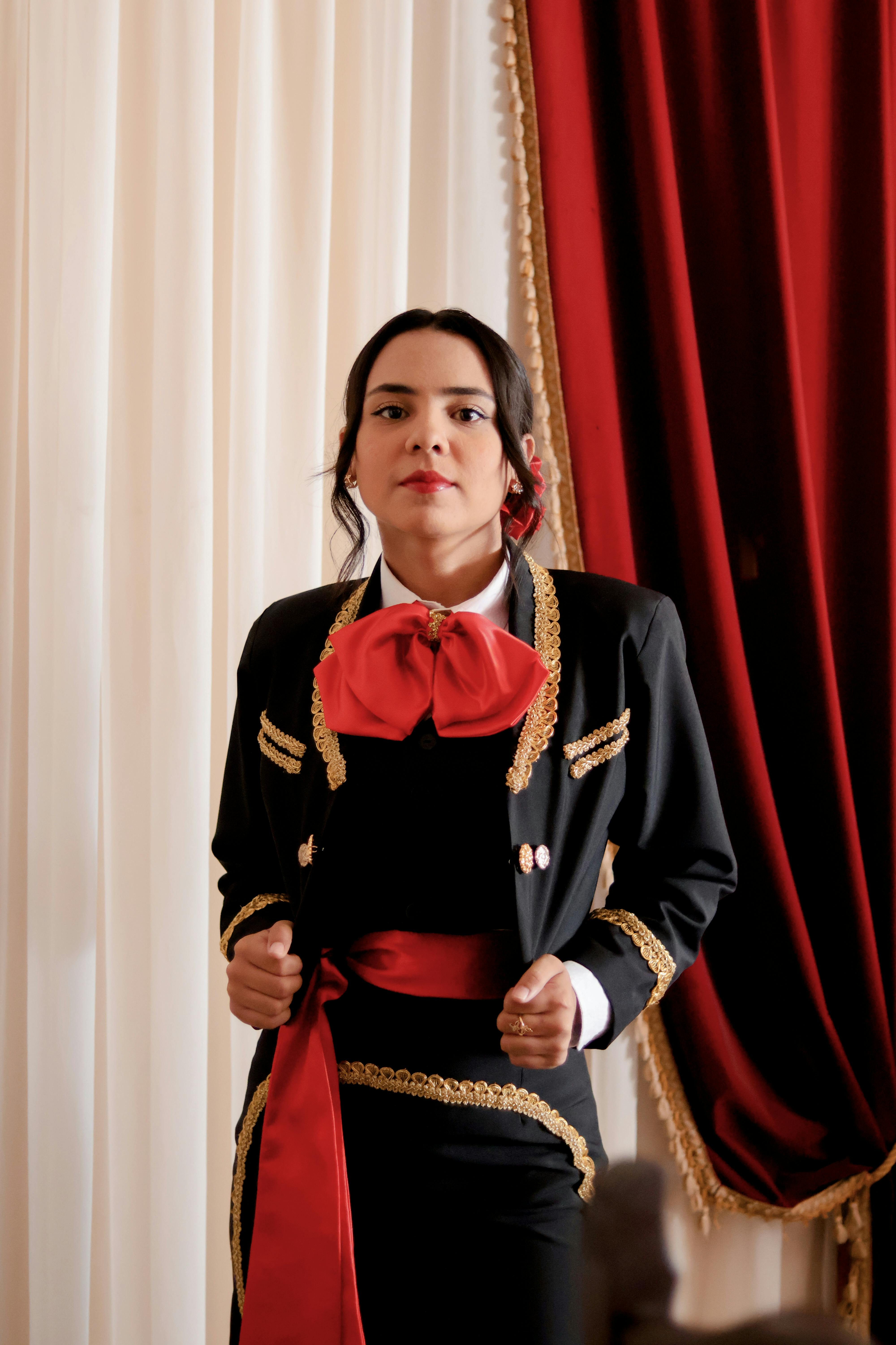 Woman in Traditional Mariachi Suit with Red Bow Tie · Free Stock Photo