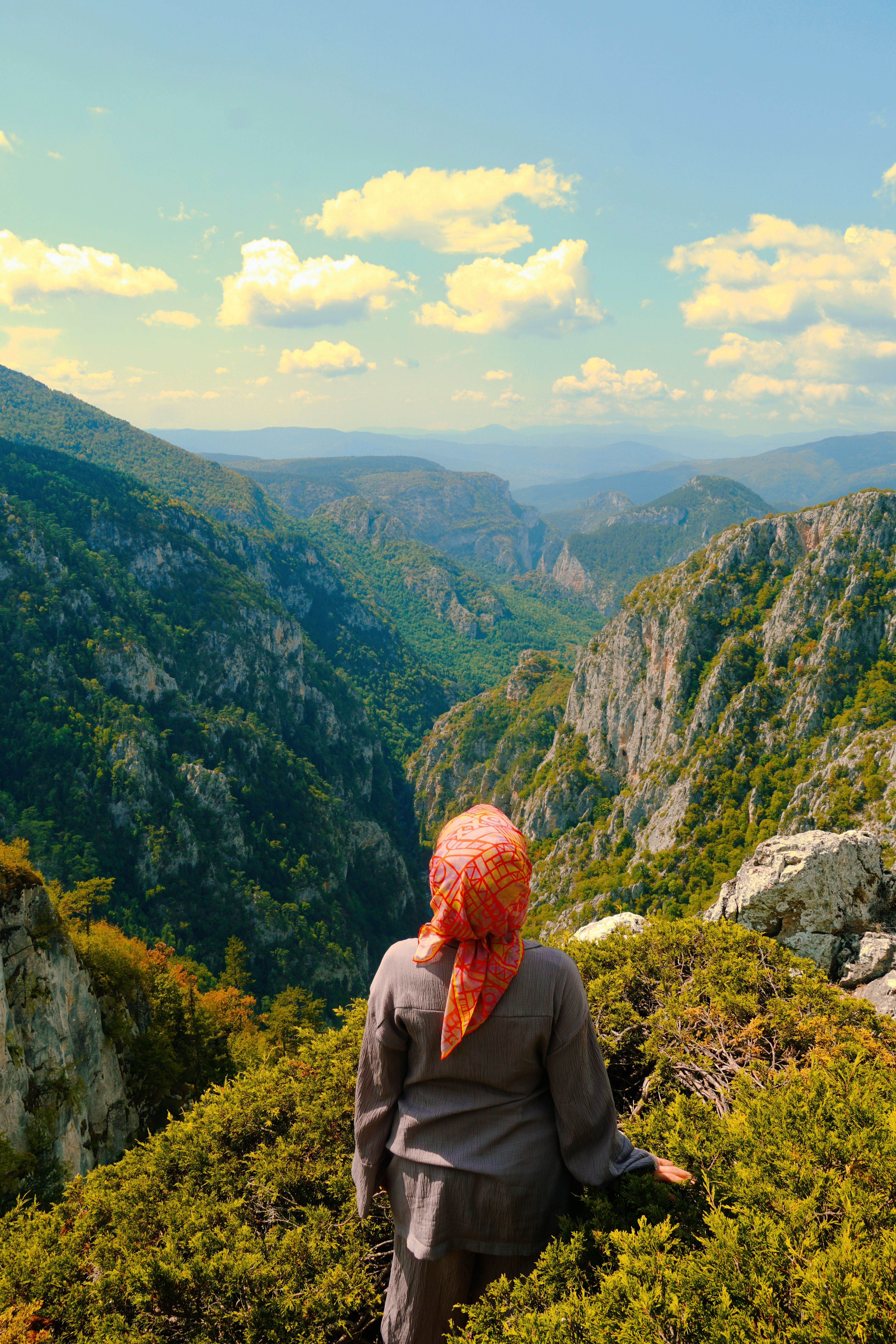 Woman in headscarf overlooking breathtaking canyon · Free Stock Photo