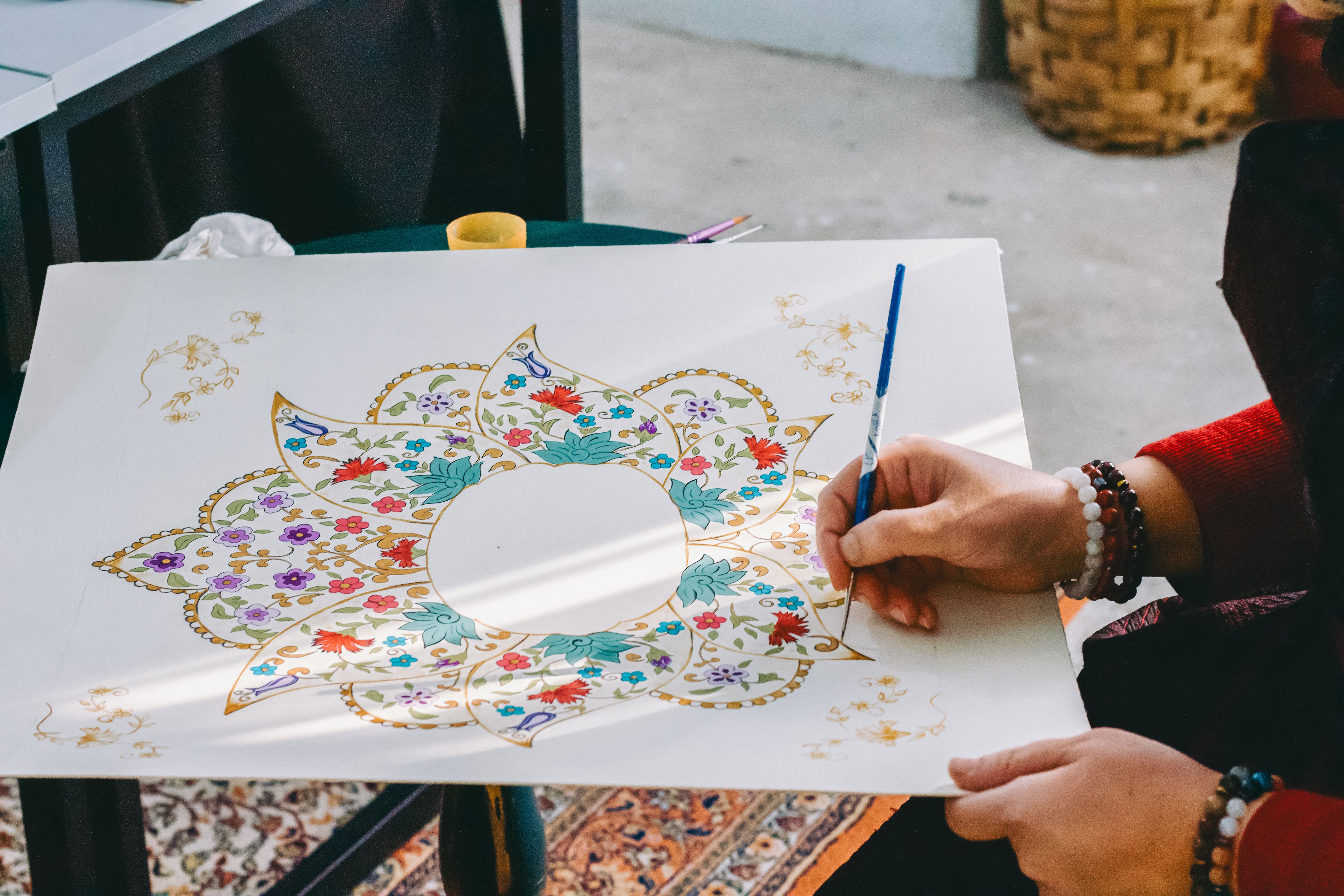 Artist Creating Detailed Floral Mandala Art Design · Free Stock Photo