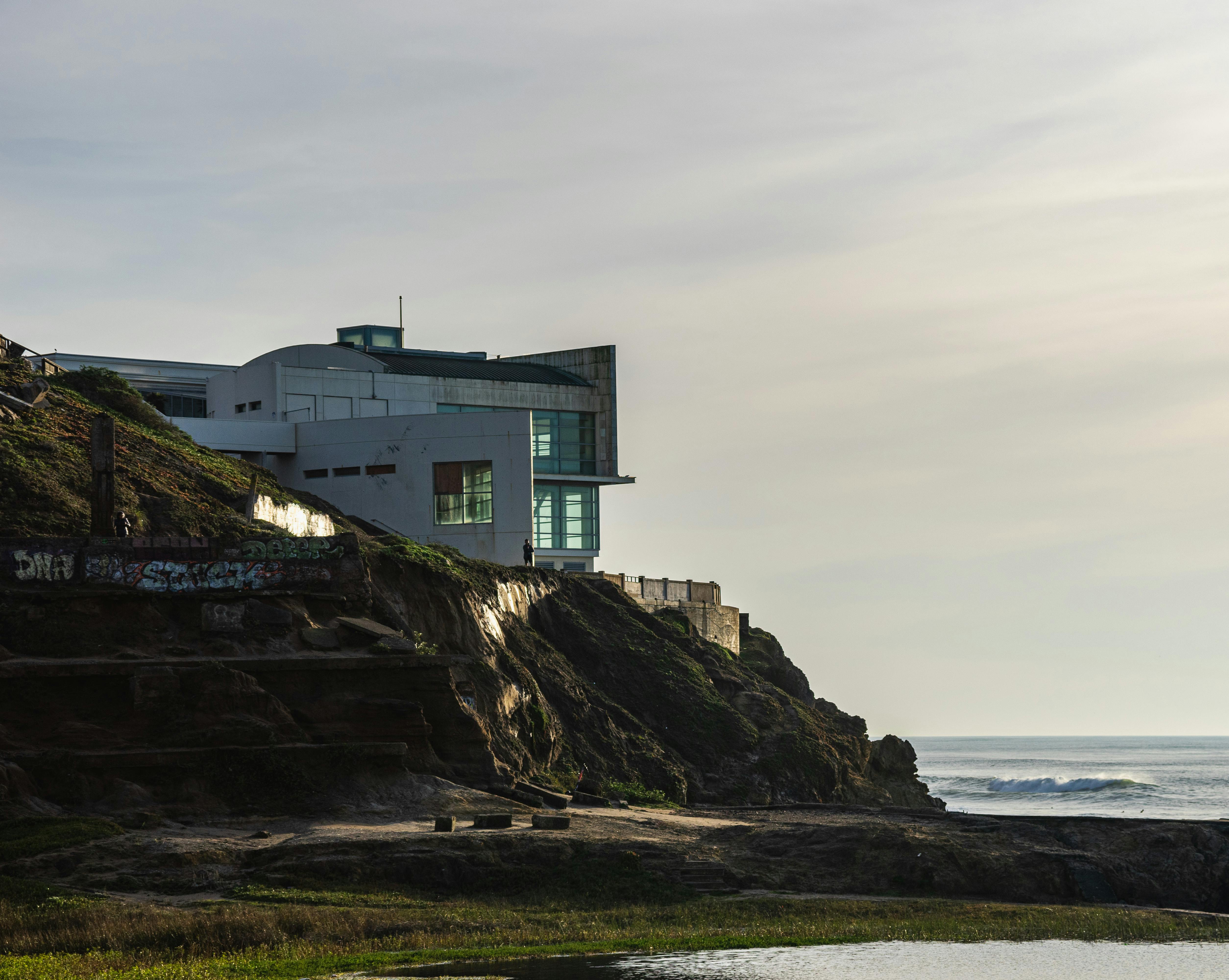 Modern Cliffside Building Overlooking Ocean · Free Stock Photo