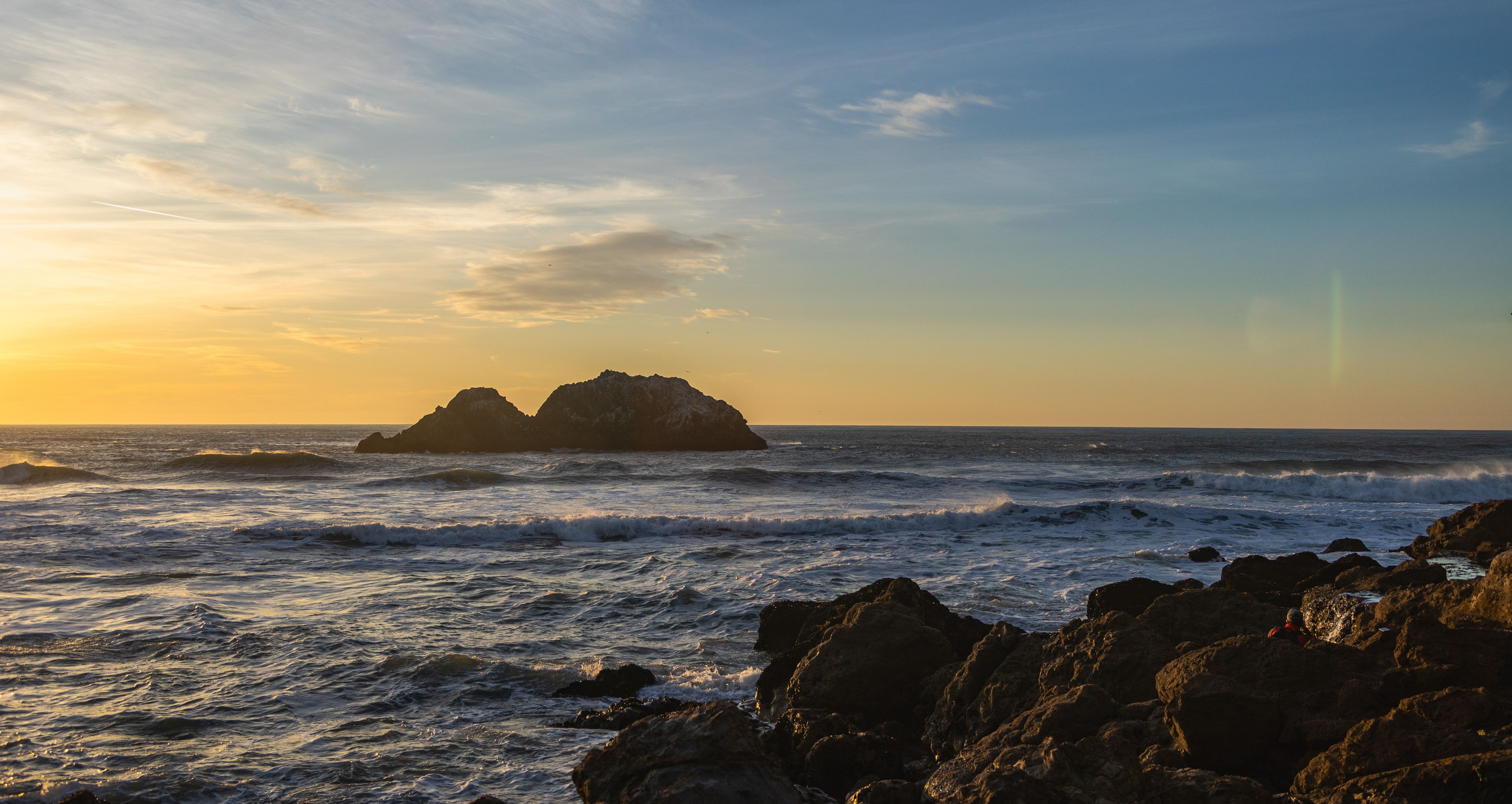Scenic Ocean View at Sunset with Rocky Shore · Free Stock Photo