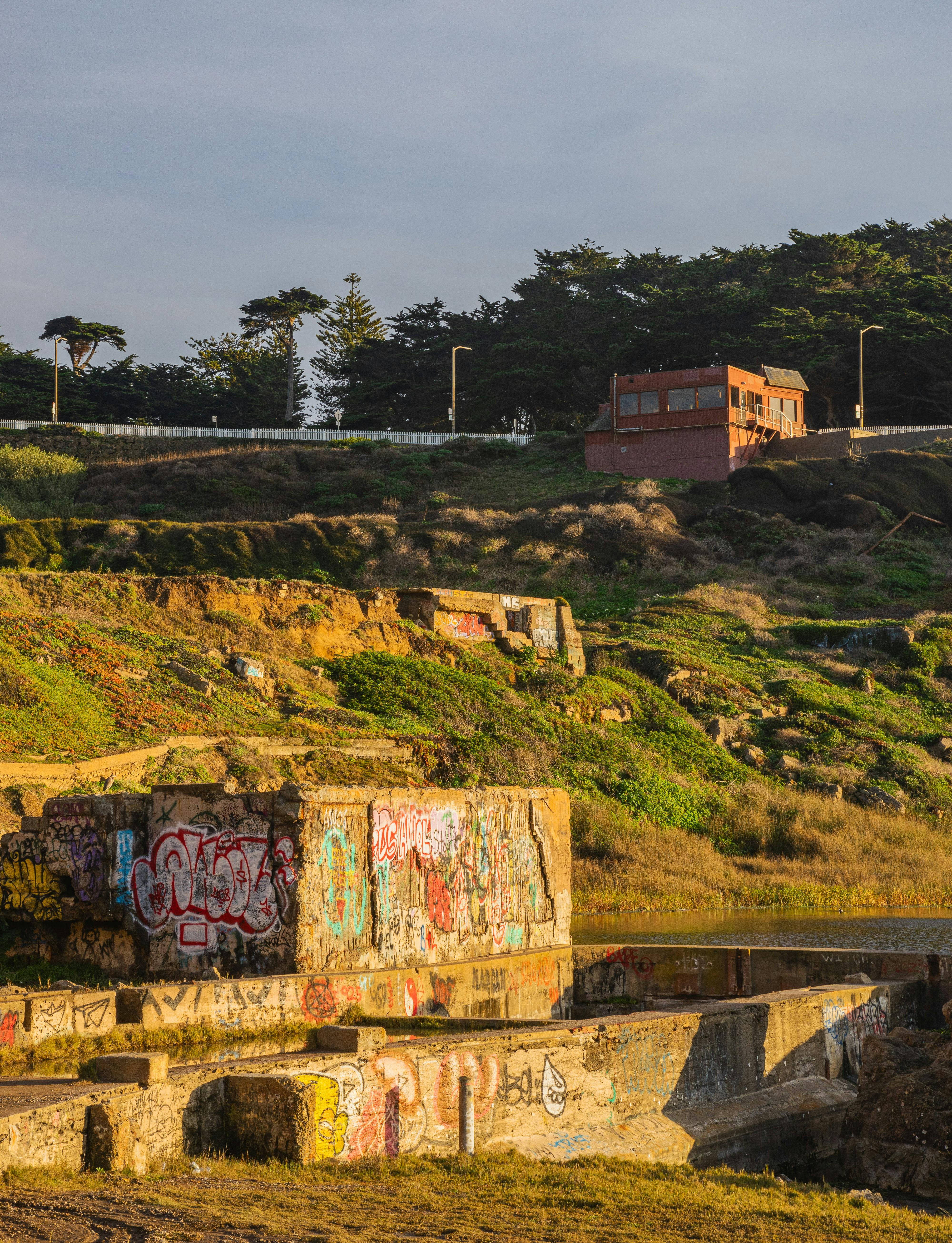 Graffiti-covered ruins in sunny landscape · Free Stock Photo