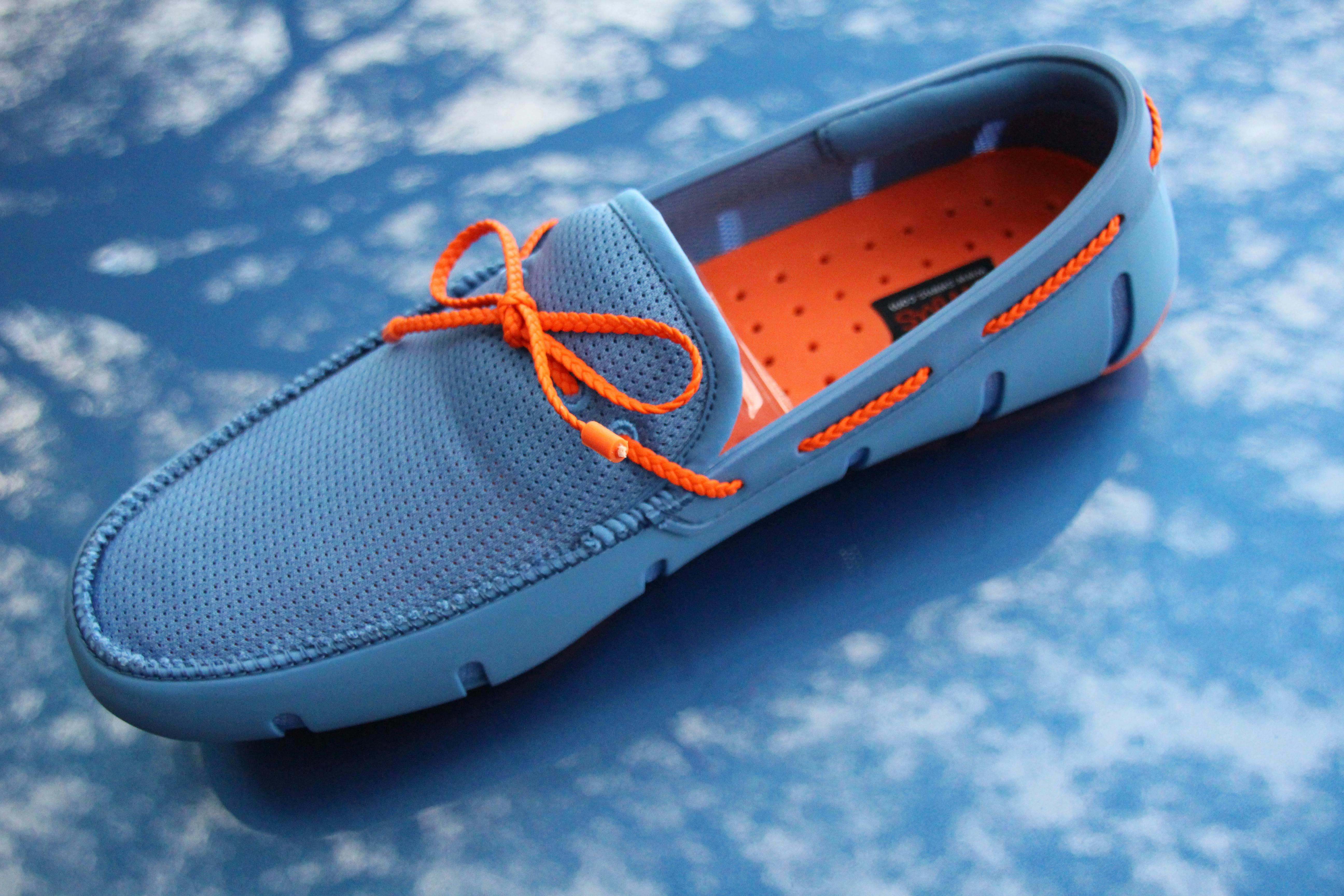 Blue Loafer with Orange Laces on Reflective Surface · Free Stock Photo
