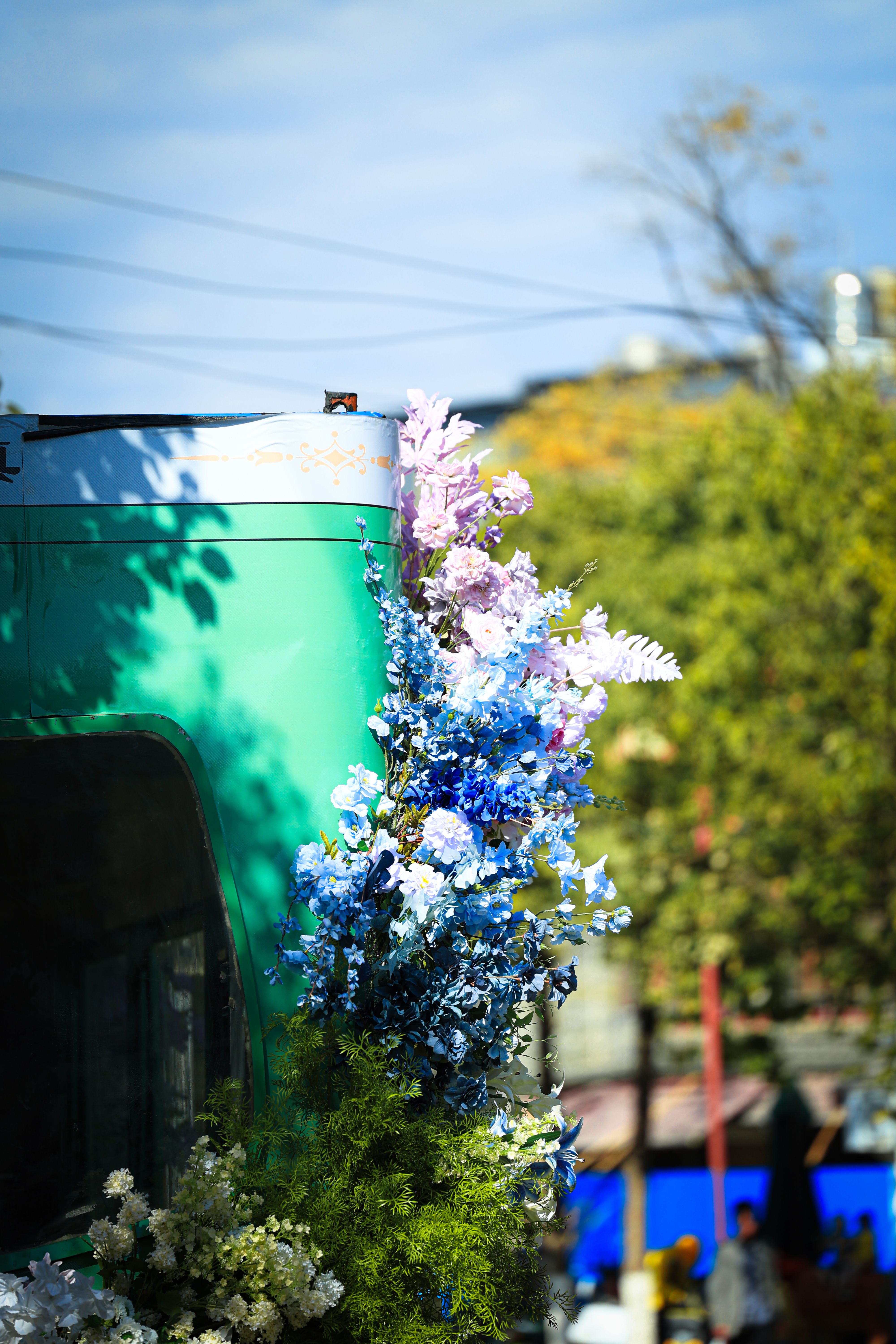 Floral Adornment on a Vintage Bus Front Outdoors · Free Stock Photo
