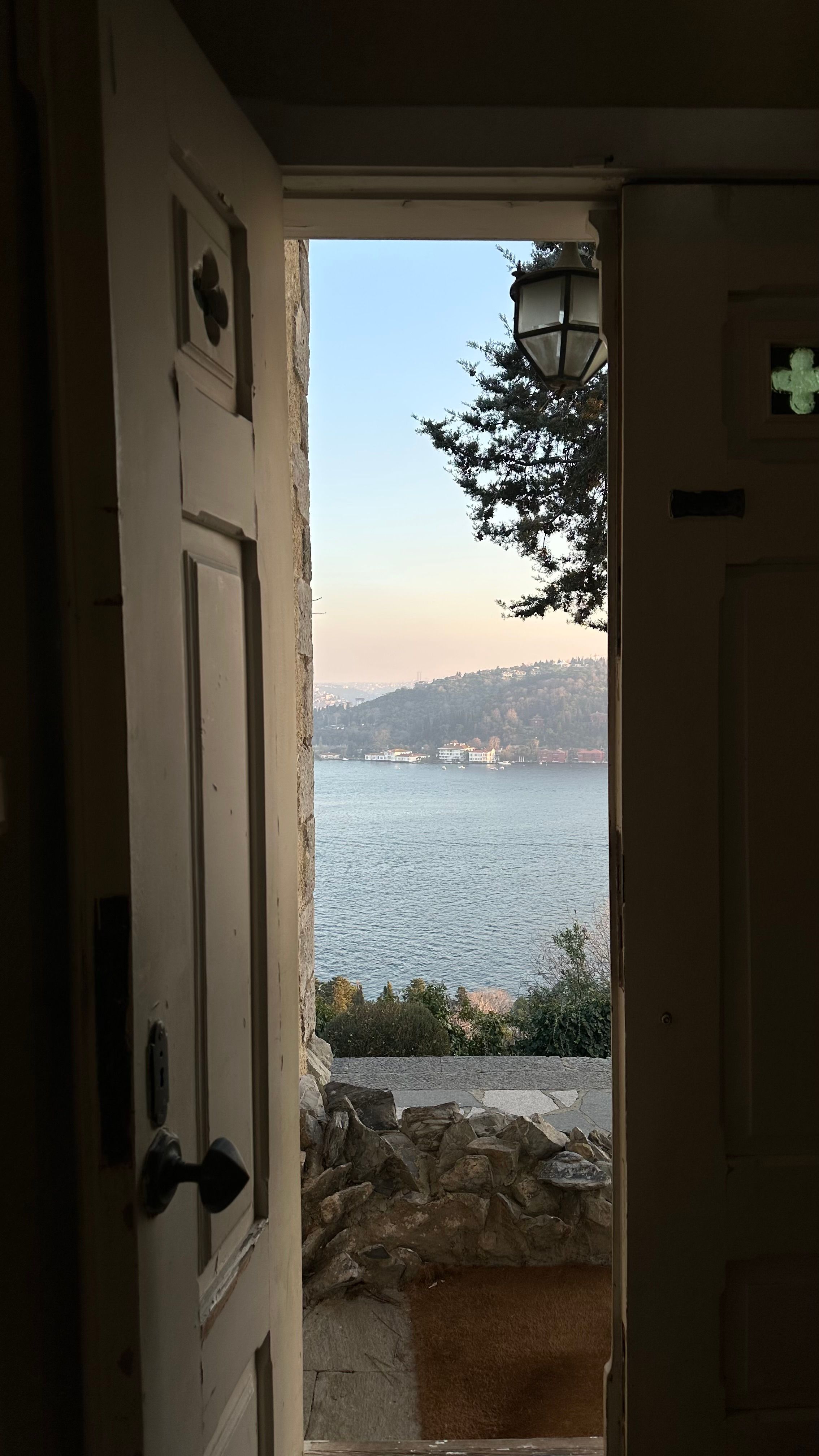 Open Door View of Tranquil Waterfront Landscape · Free Stock Photo