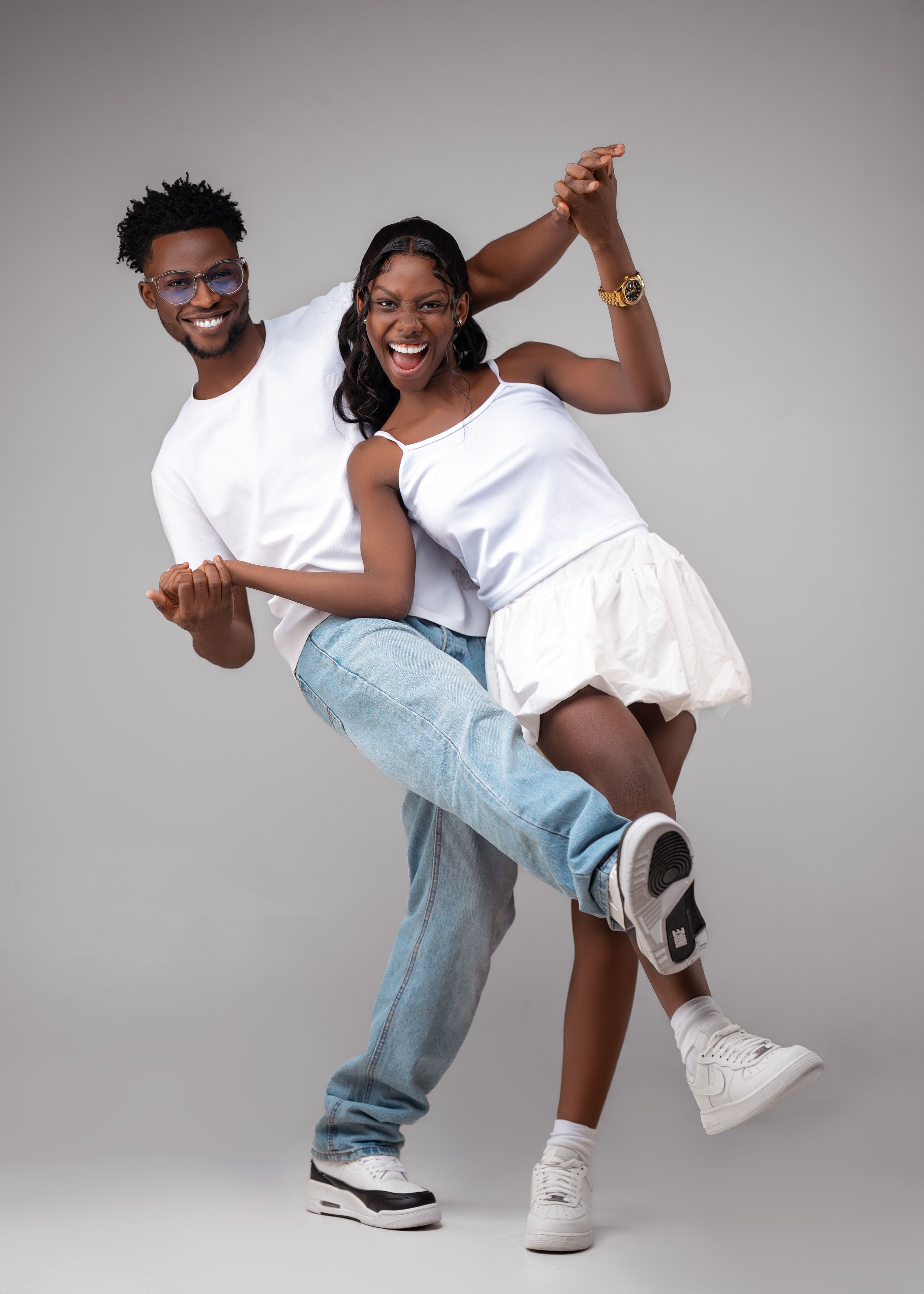 Joyful Dance Pose of Young Couple in Casual Outfits · Free Stock Photo