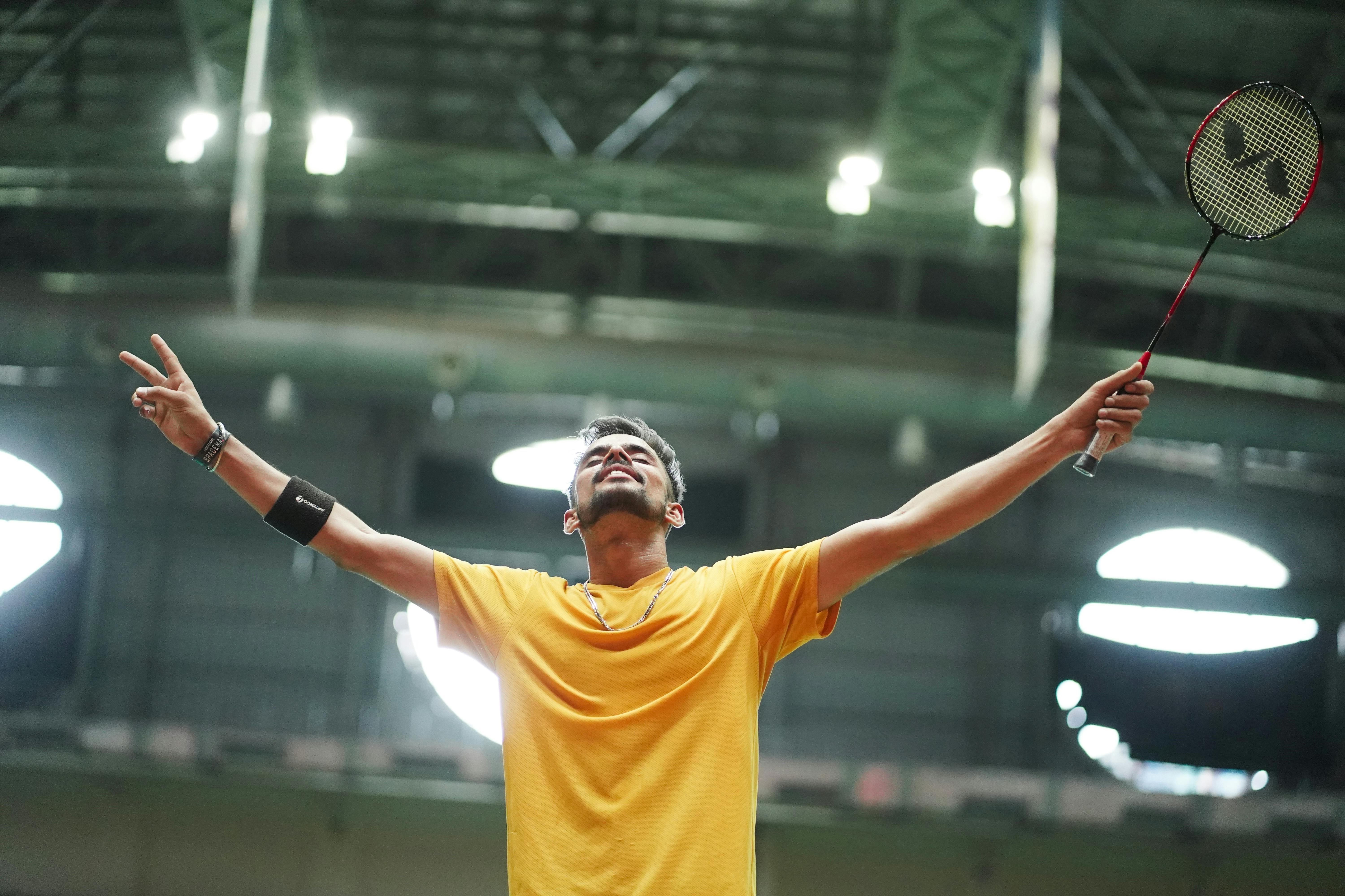 Joyful Badminton Player Celebrating Victory Indoors · Free Stock Photo