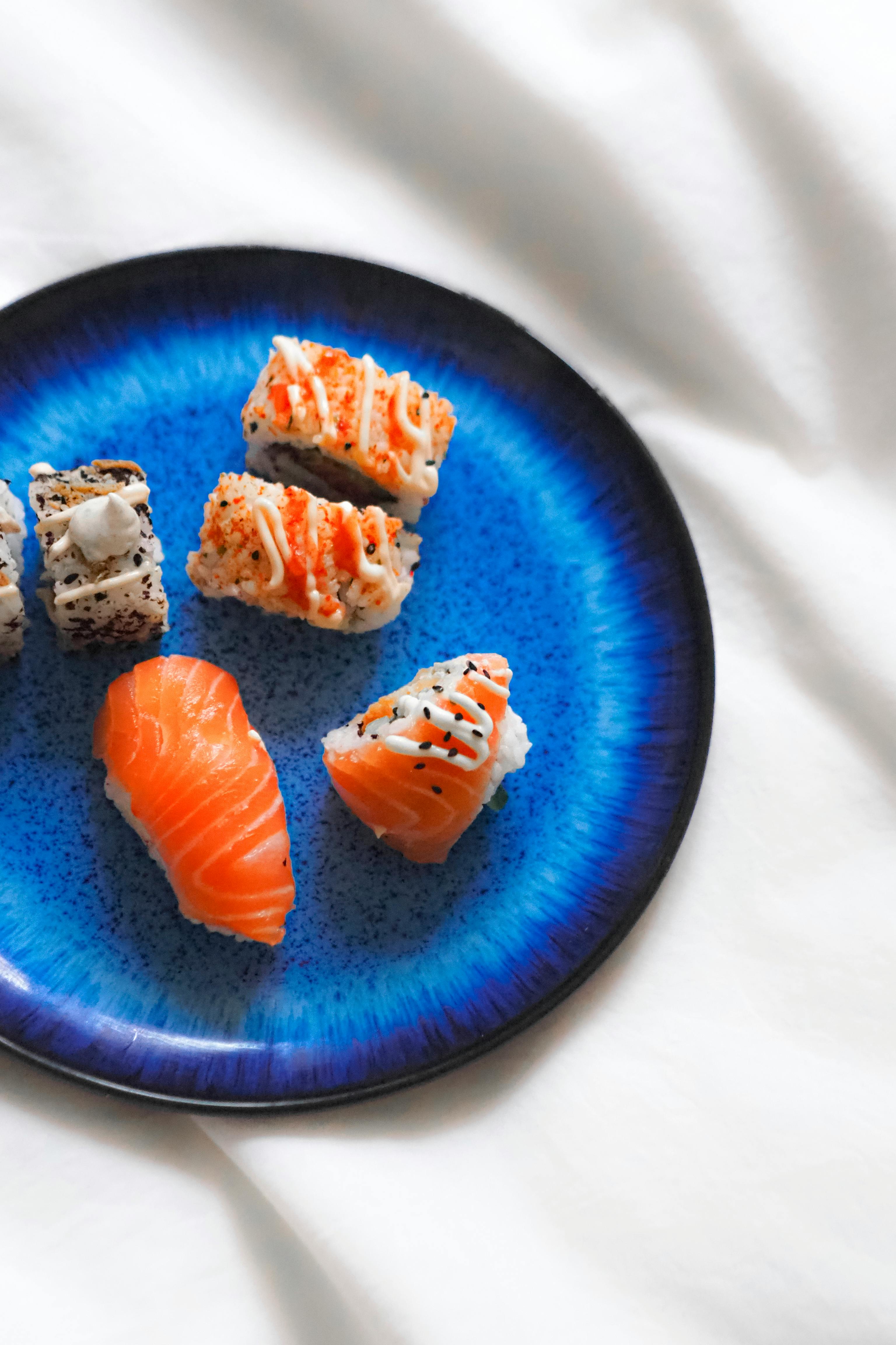 Elegant Assortment of Sushi on a Blue Plate · Free Stock Photo
