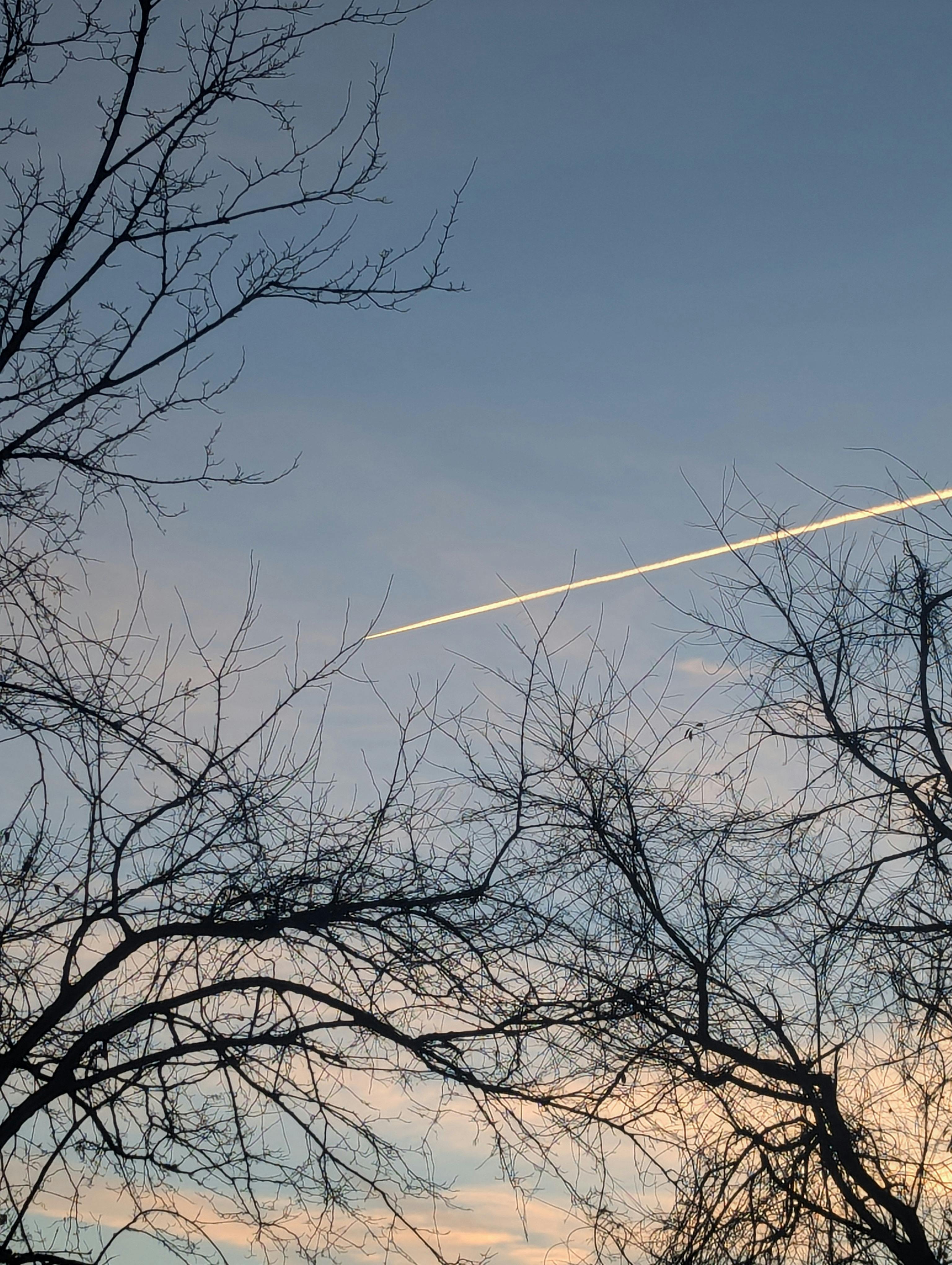Jet Contrail Across a Winter Sky at Sunset · Free Stock Photo