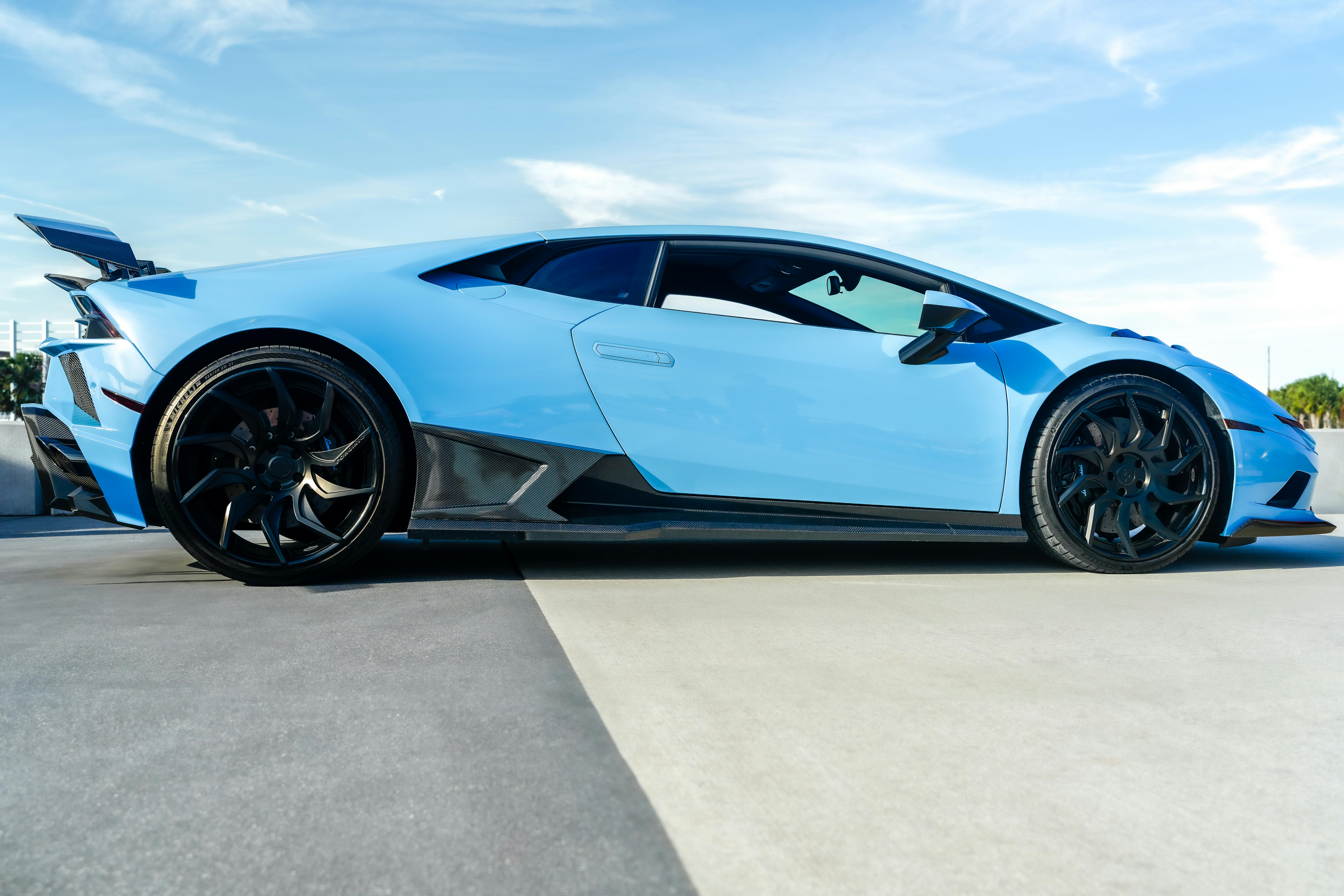 Sleek Blue Sports Car Parked in Sunlight · Free Stock Photo