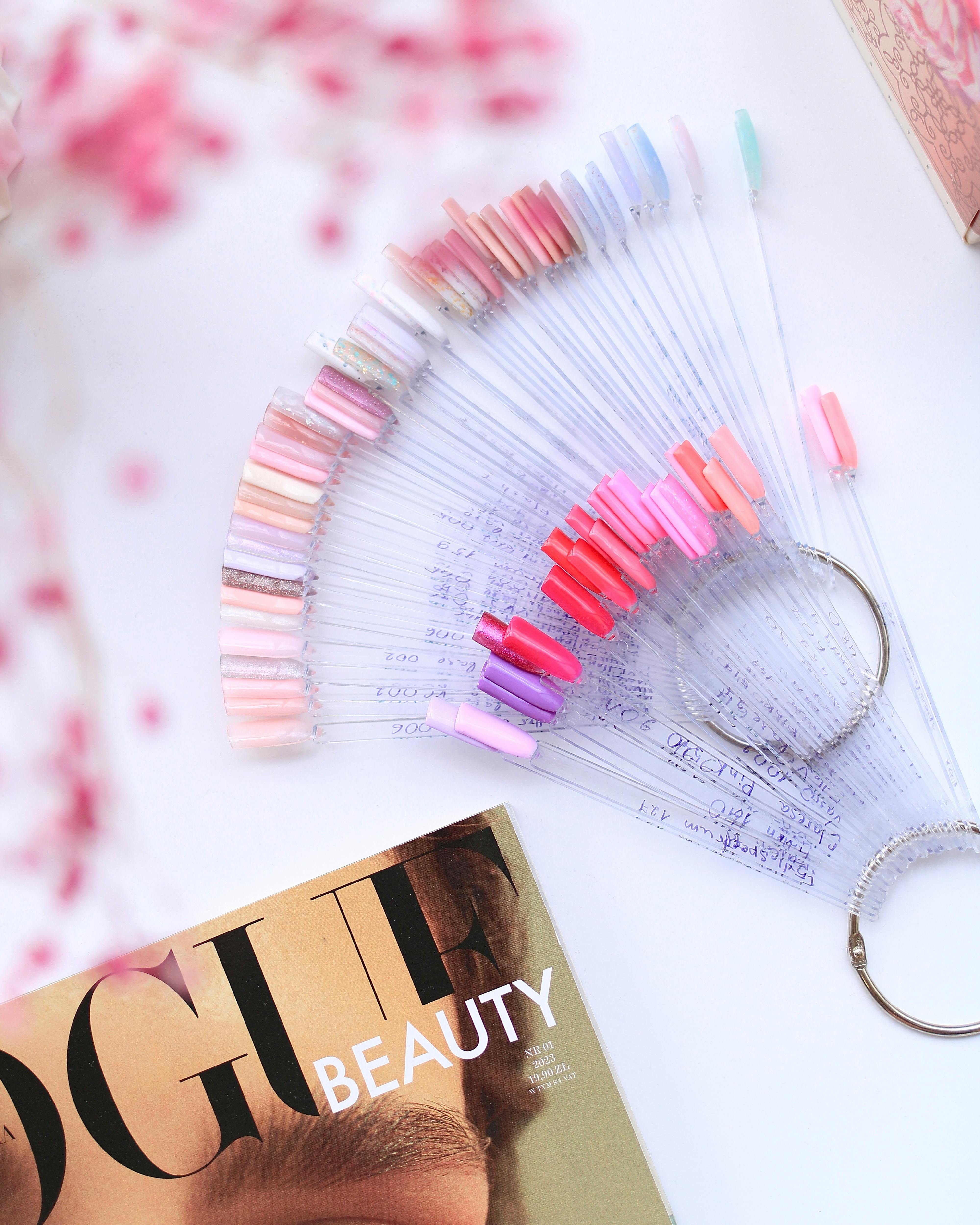 Colorful Nail Polish Swatches with Fashion Magazine · Free Stock Photo