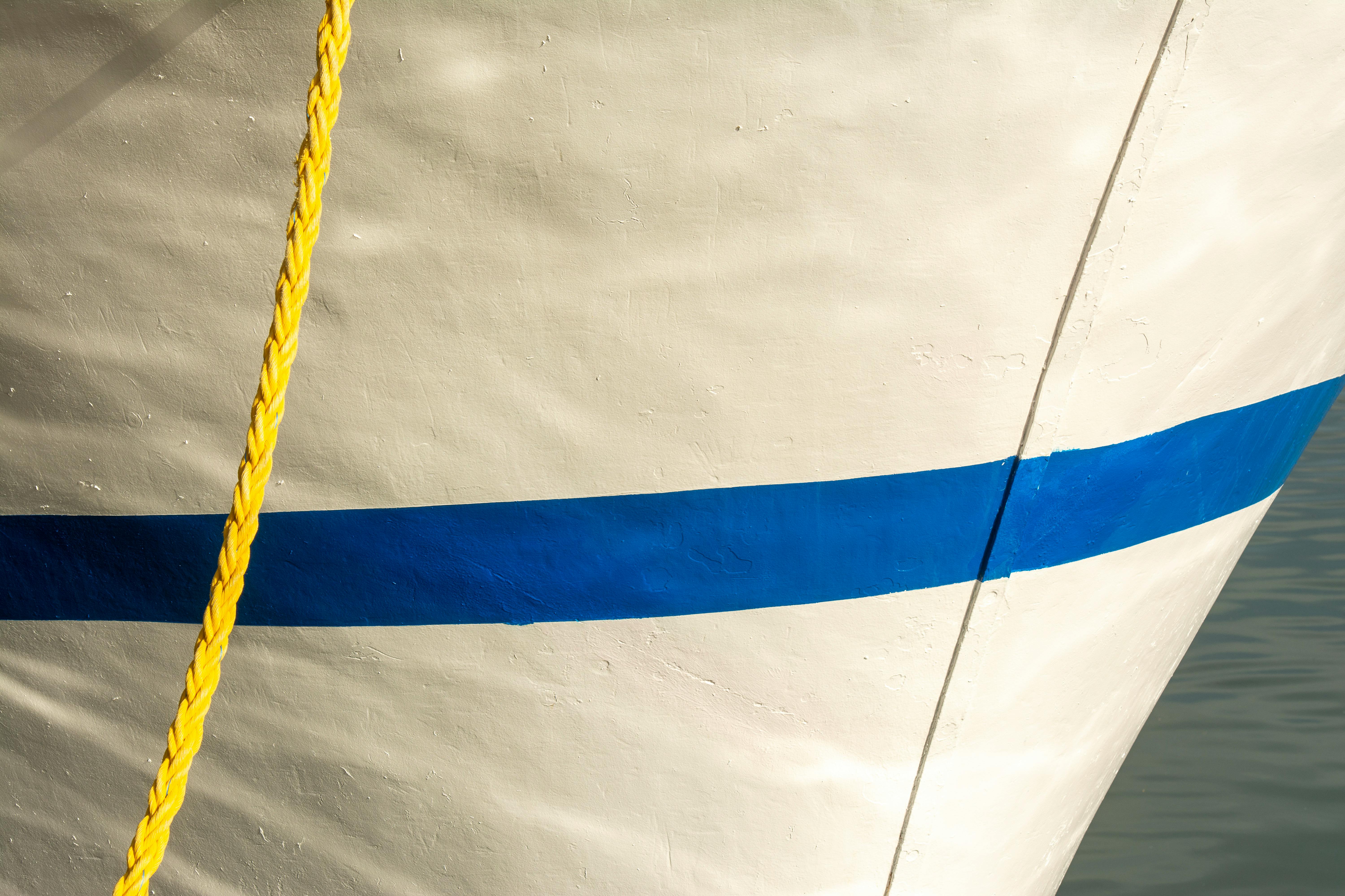 Close-Up of a Boat's Prow with Blue Stripe · Free Stock Photo