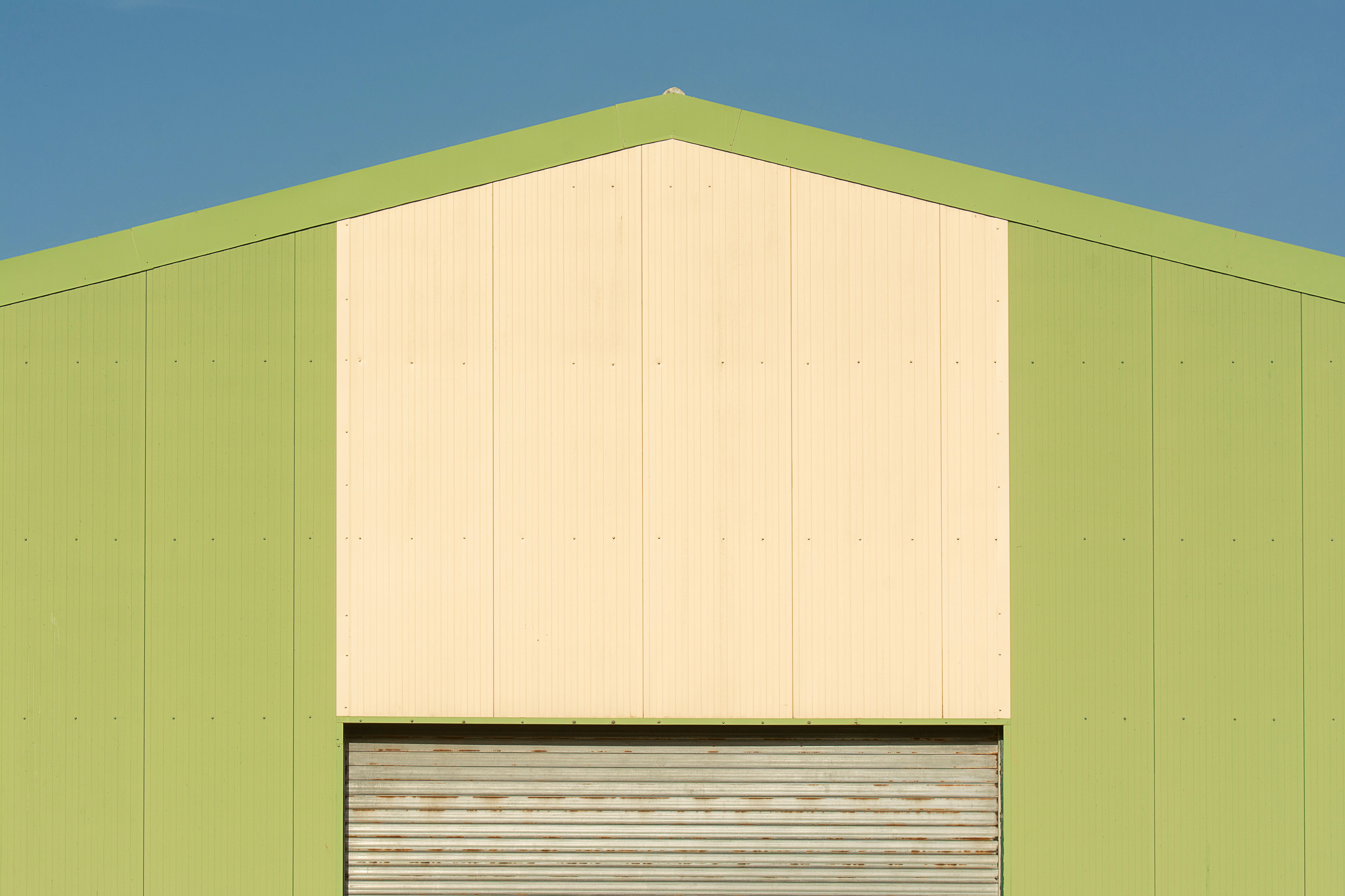 Symmetrical Green Industrial Warehouse Exterior · Free Stock Photo