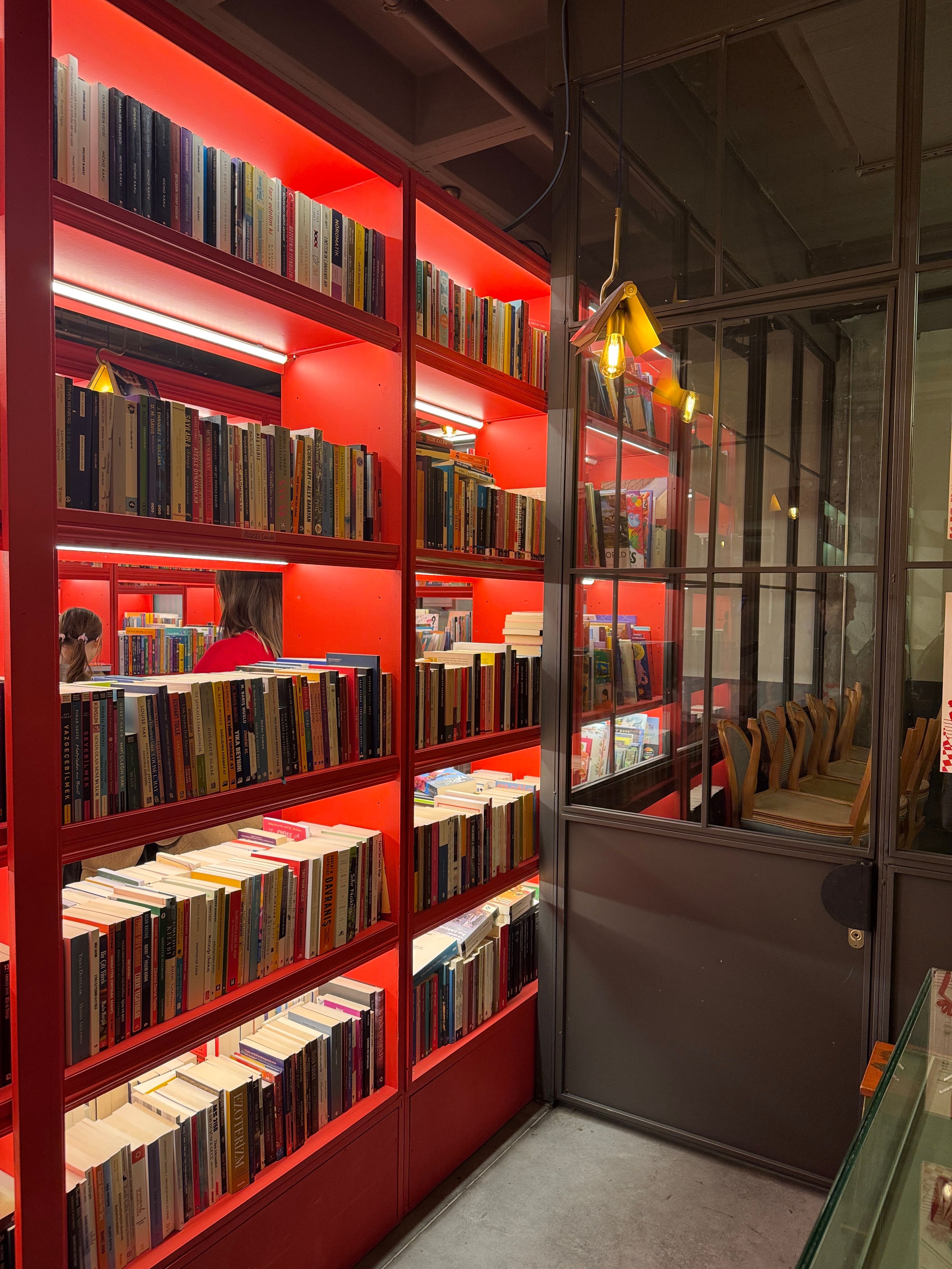 Cozy Bookstore Interior with Vibrant Red Shelves · Free Stock Photo