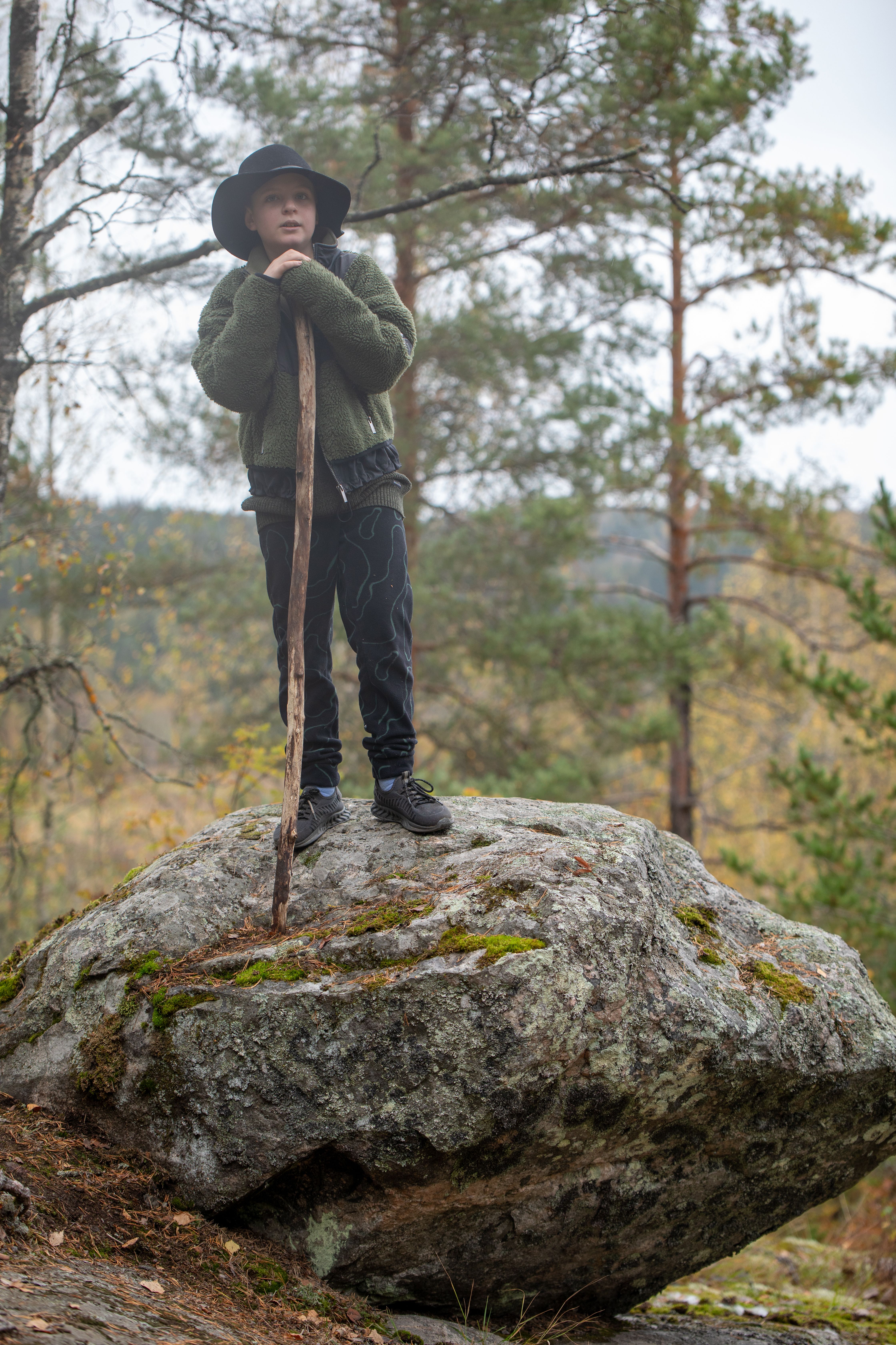 Child Adventurer Standing on Boulder in Forest · Free Stock Photo