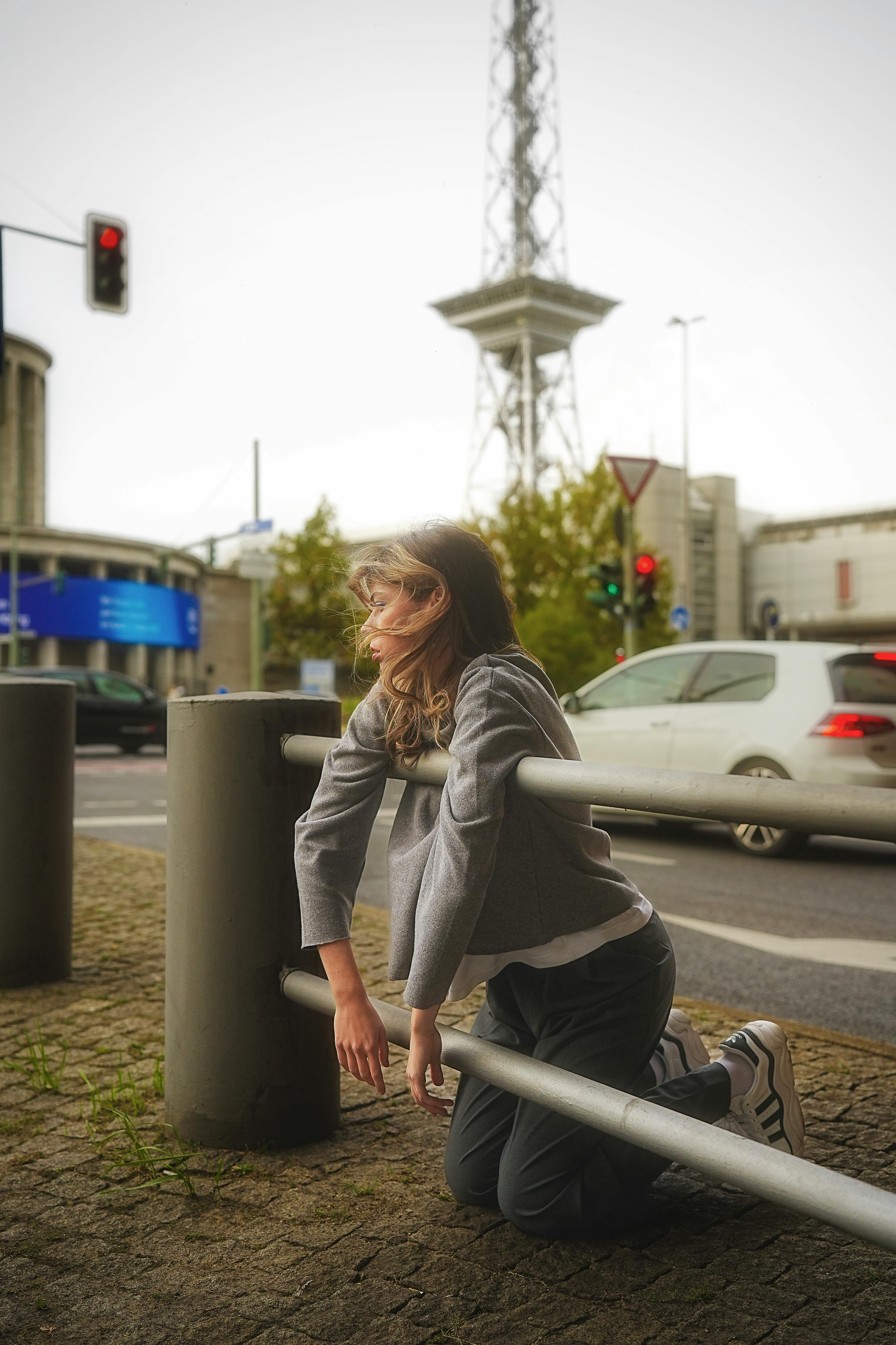 Young Woman Kneeling by Berlin Landmark in Fall · Free Stock Photo