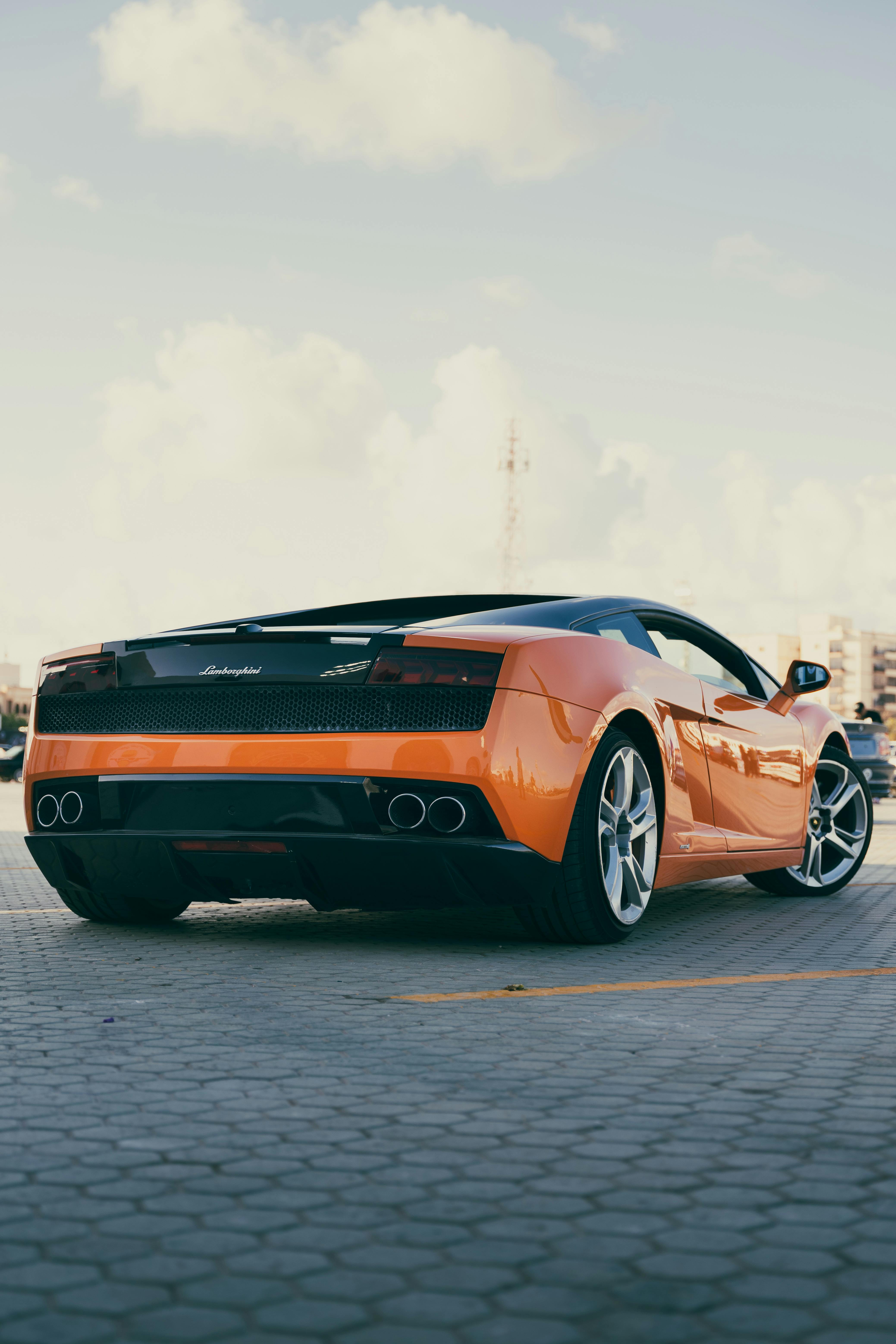 Sleek Orange Lamborghini in Benghazi Parking Lot · Free Stock Photo