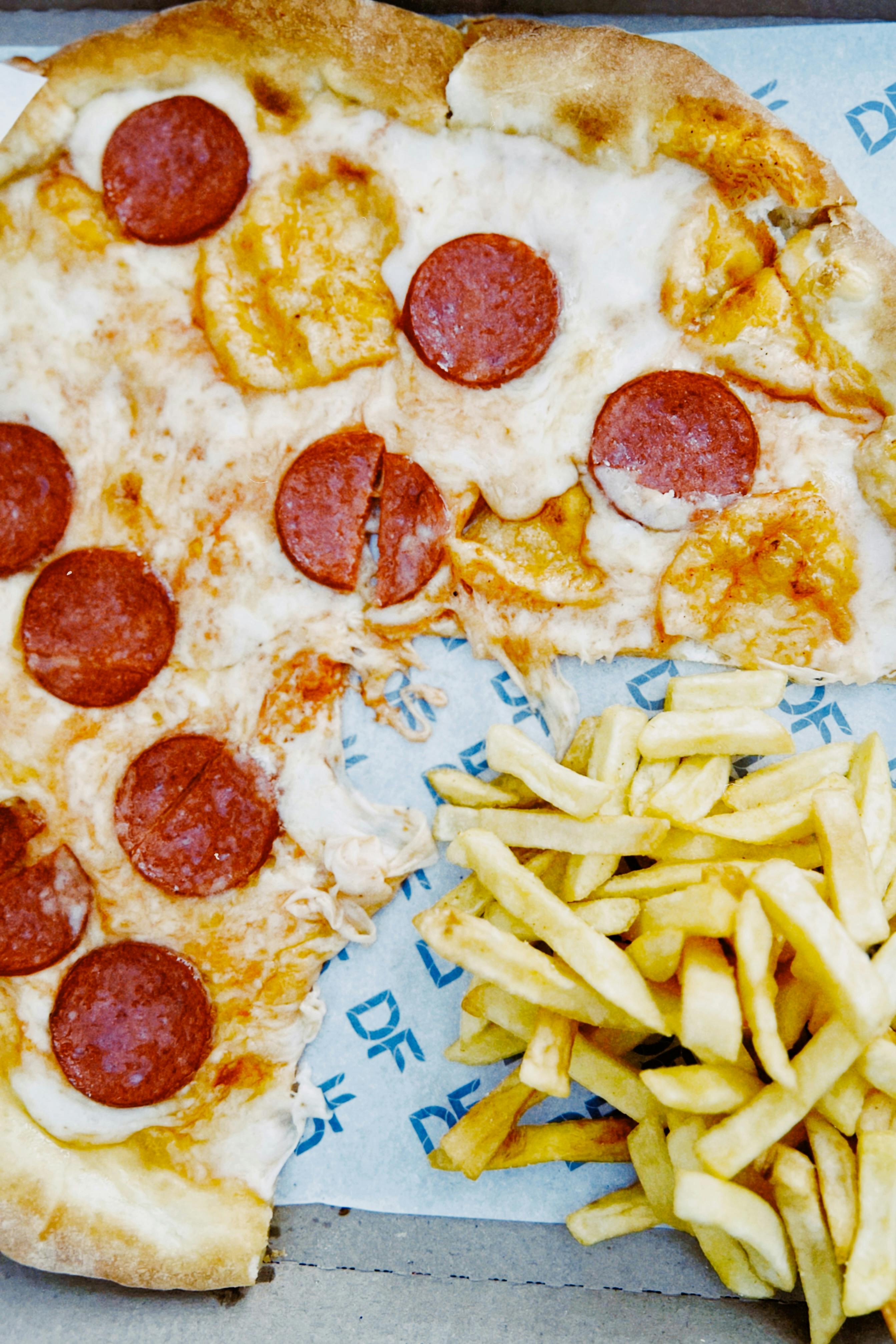 Delicious Pepperoni Pizza and Fries Top View · Free Stock Photo