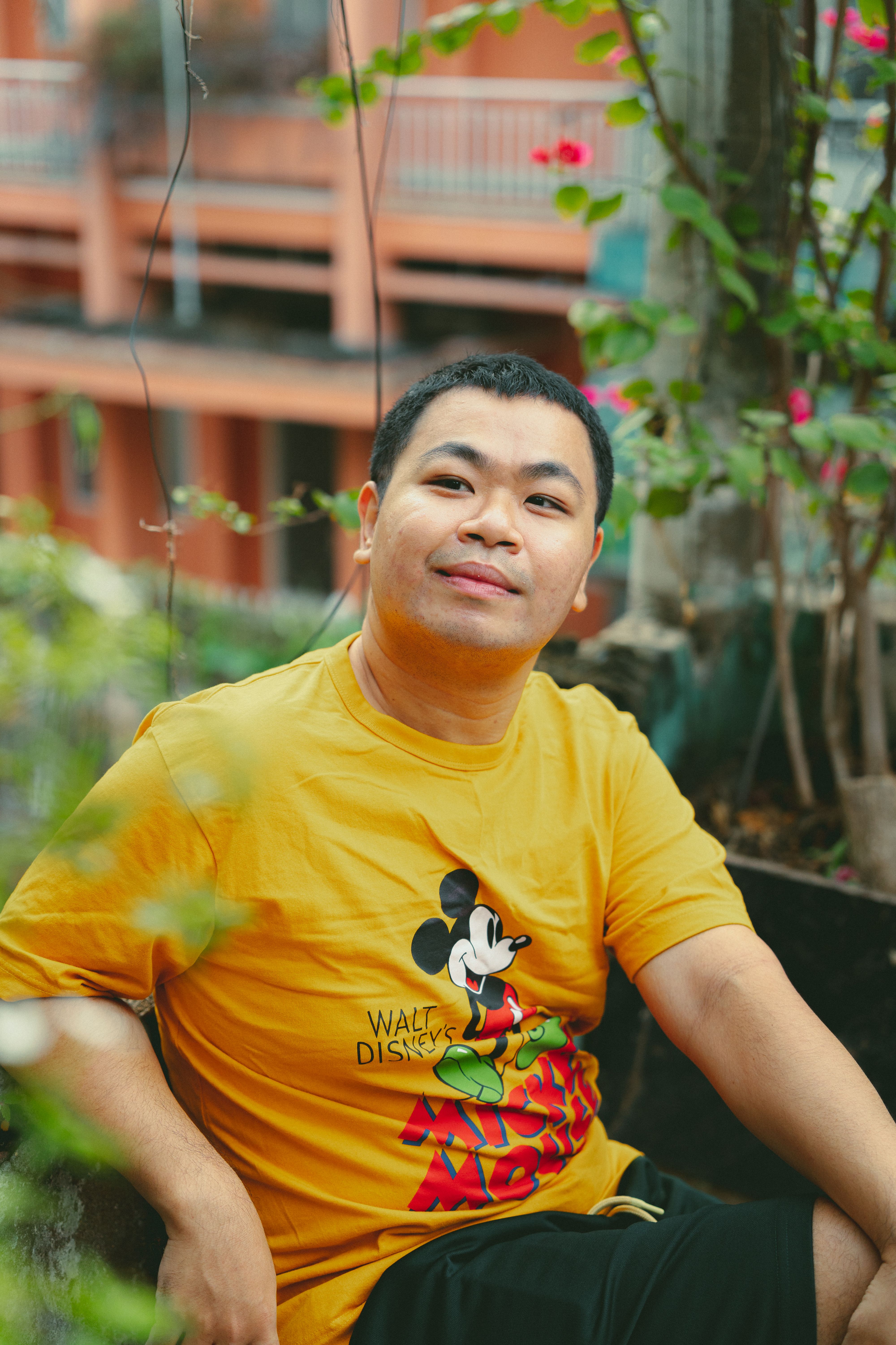 Portrait of Man Sitting Among Shrubs in a Park · Free Stock Photo