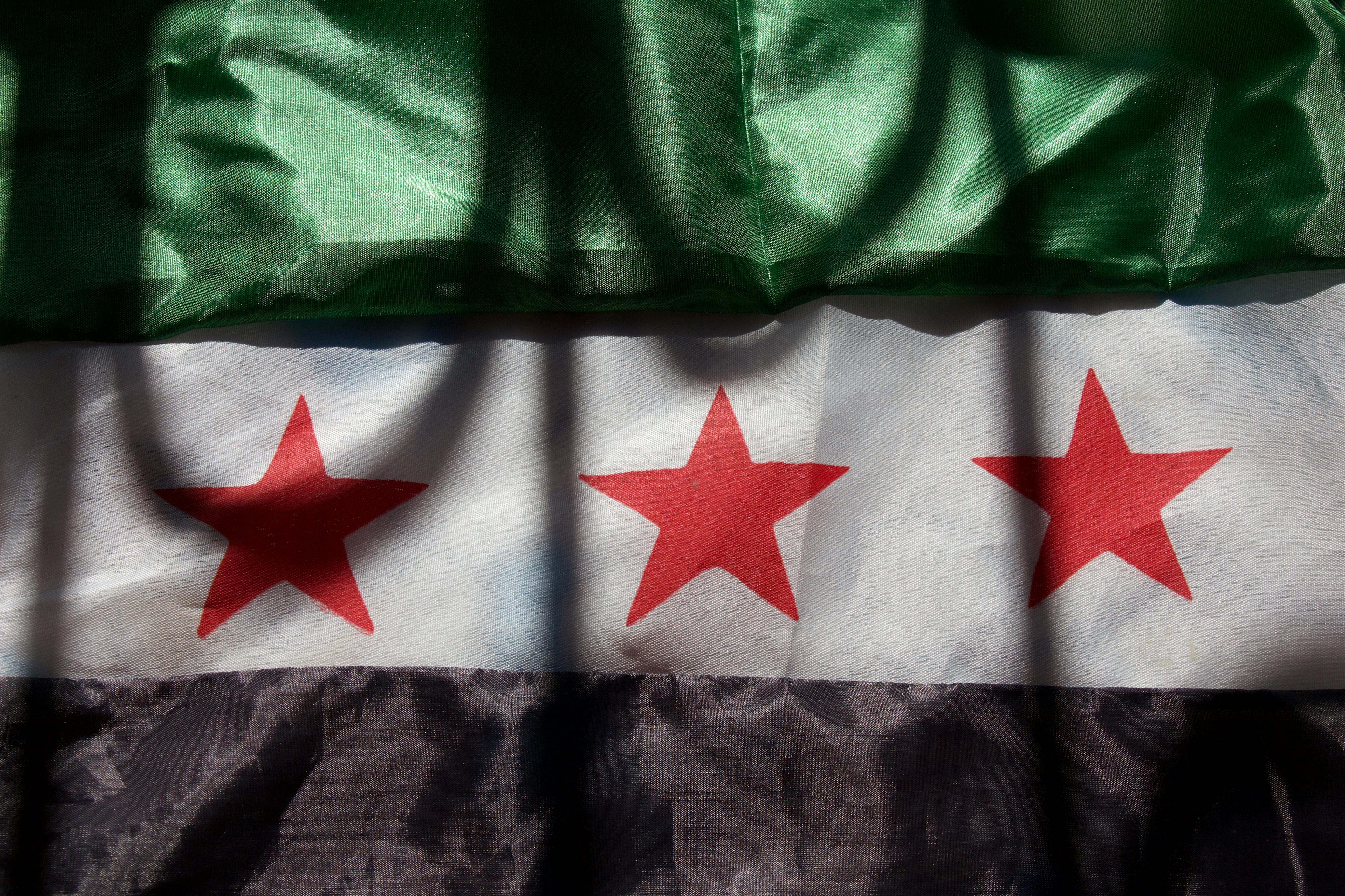 Close-up of Syrian Flag with Red Stars · Free Stock Photo