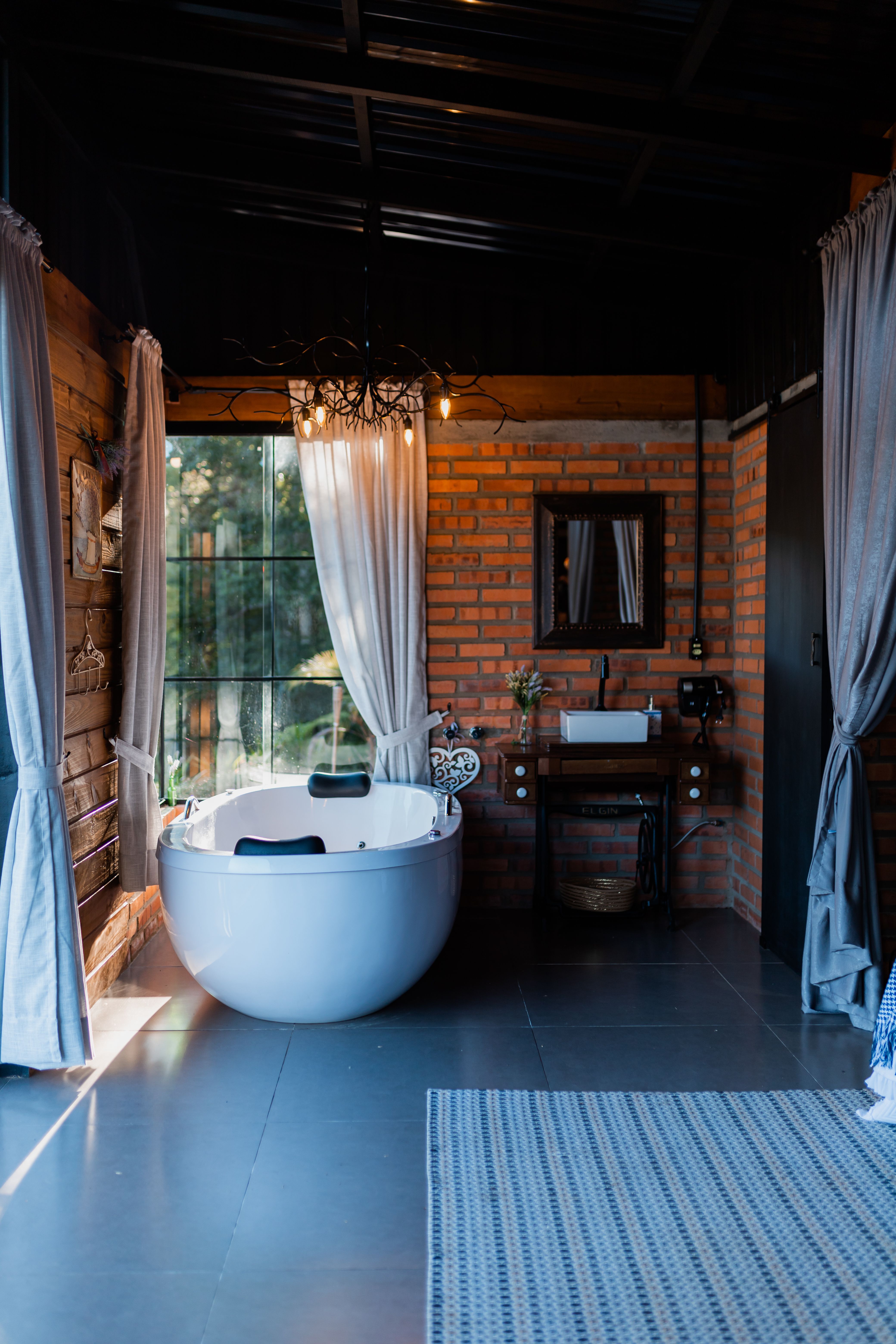 Rustic Bathroom with Freestanding Tub and Brick Wall · Free Stock Photo