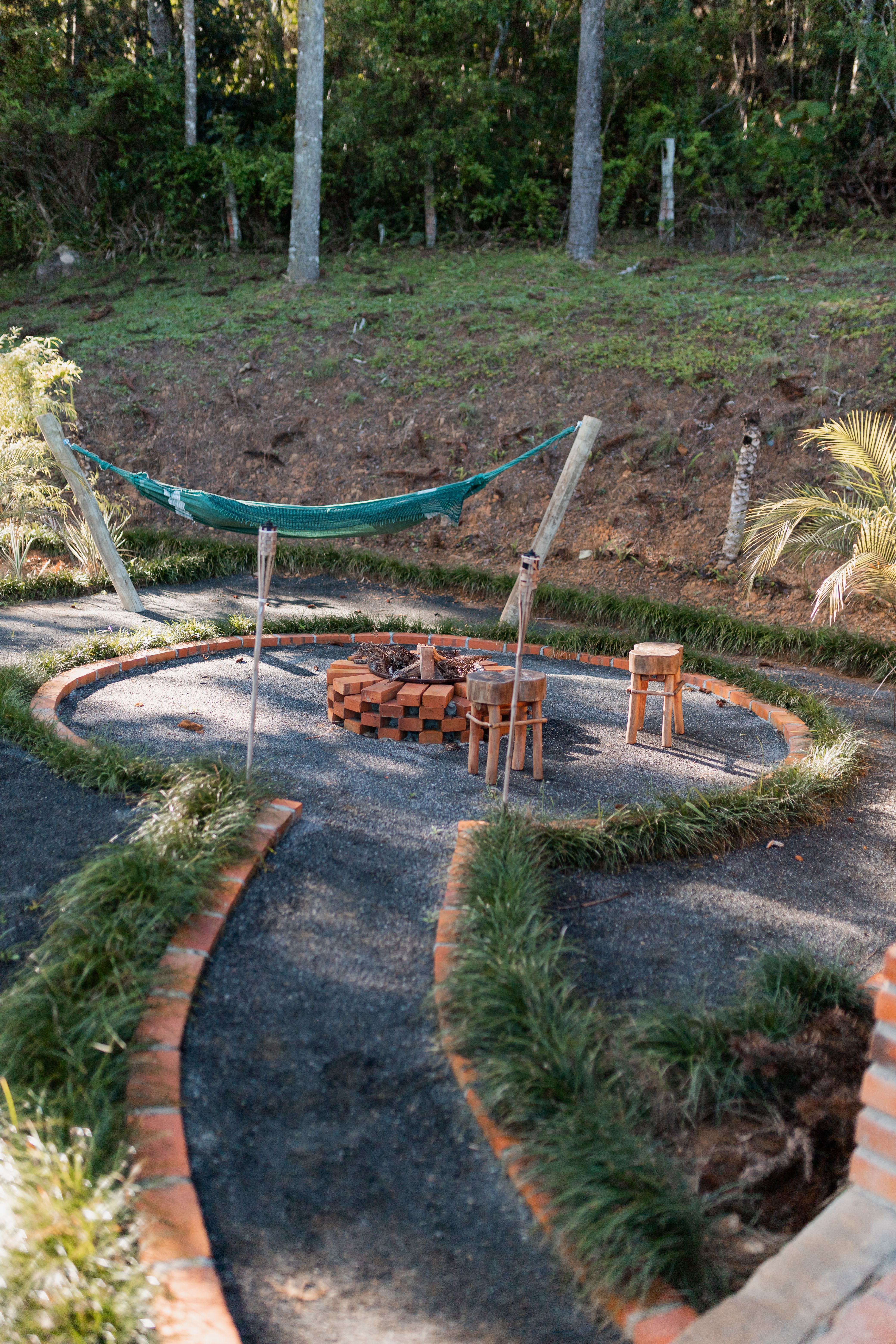 Tranquil Outdoor Fire Pit in a Forest Setting · Free Stock Photo