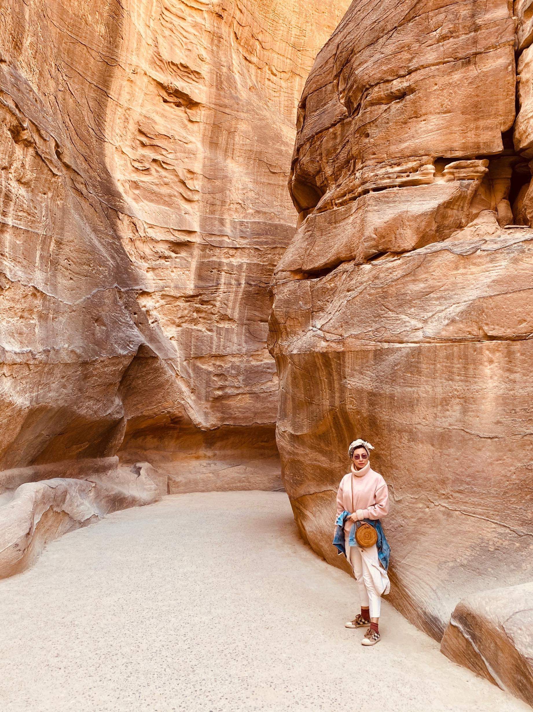 Person exploring ancient sandstone canyon in Jordan · Free Stock Photo