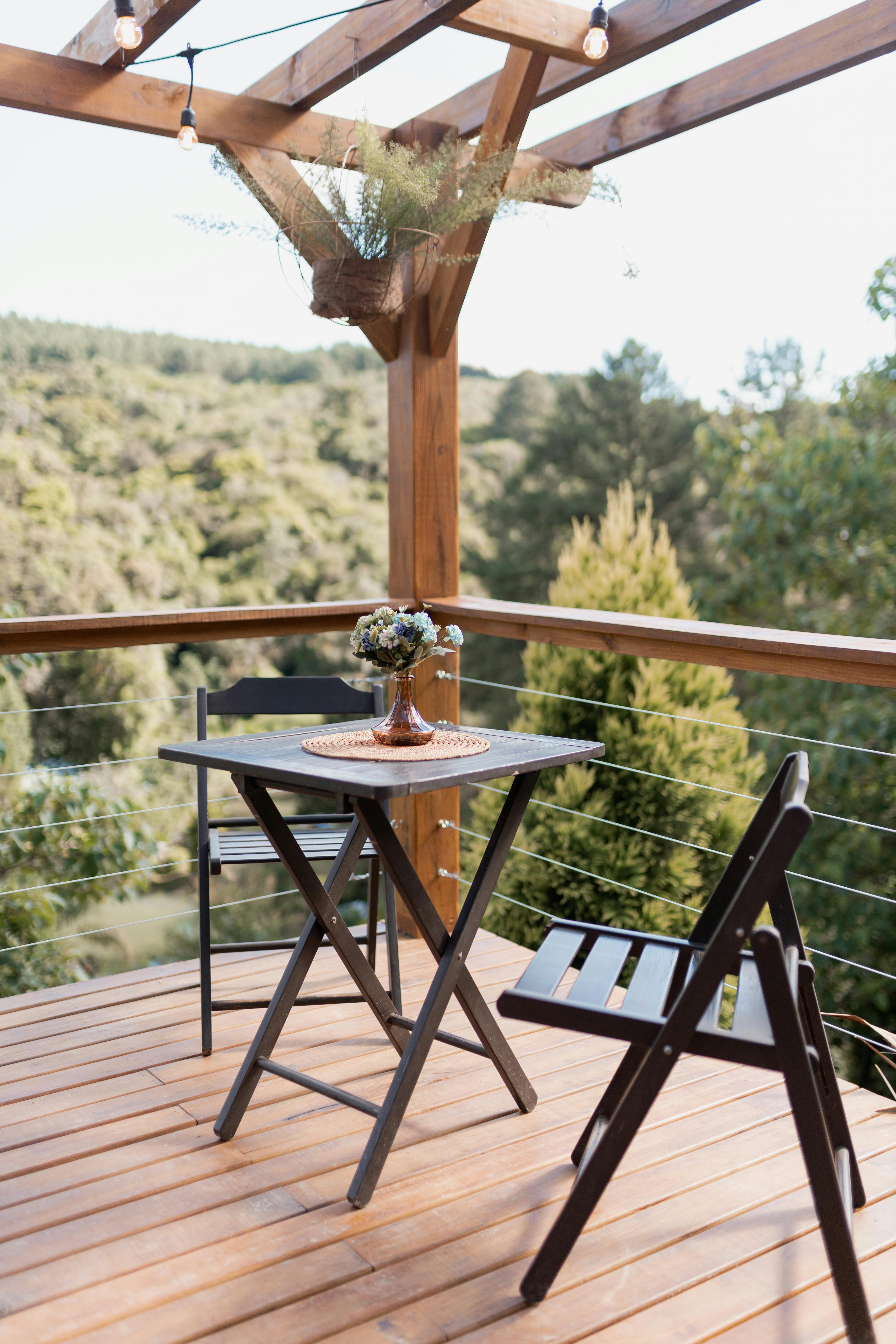 Scenic Outdoor Deck Dining with Forest View · Free Stock Photo