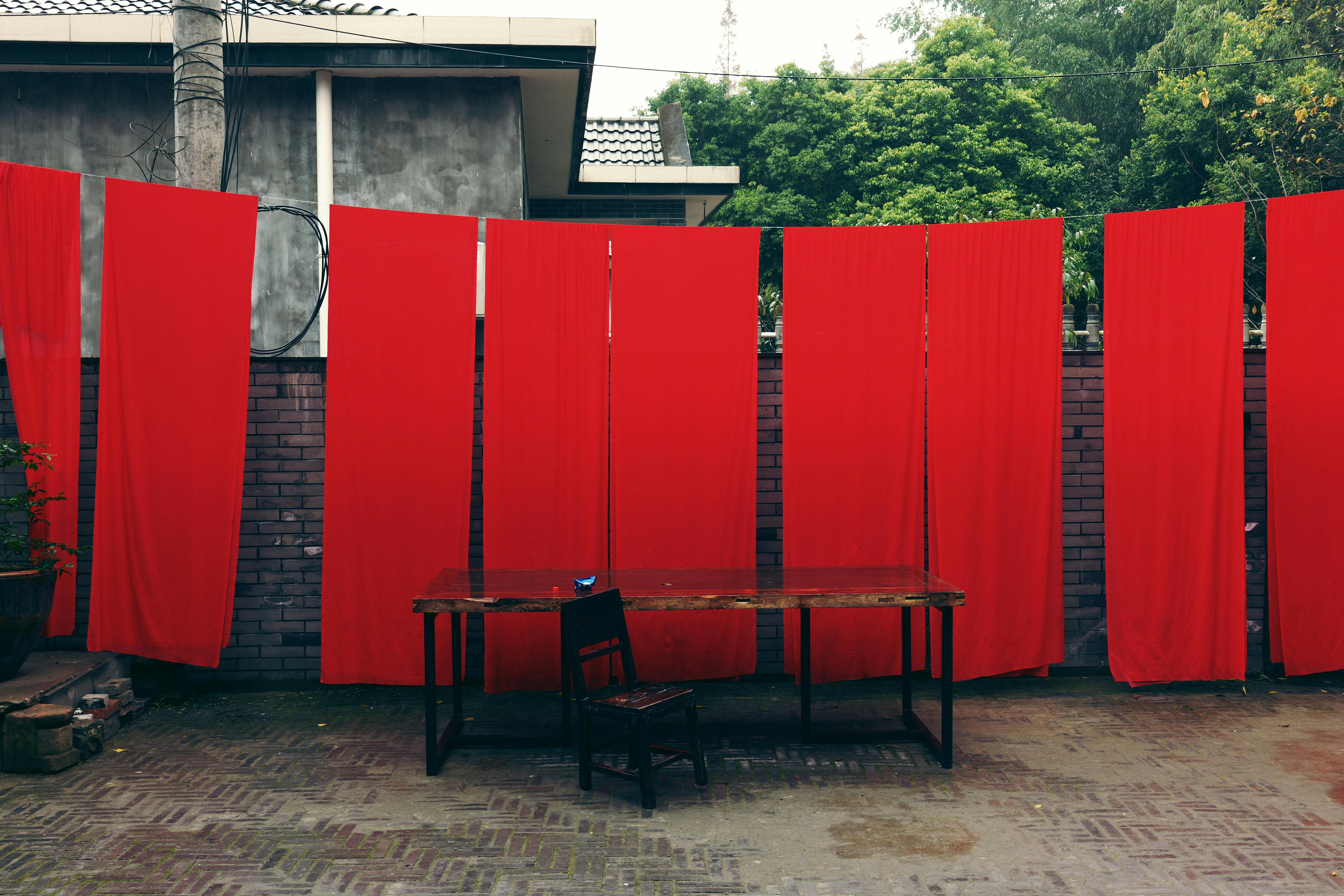 Outdoor Scene with Red Curtains and Table · Free Stock Photo