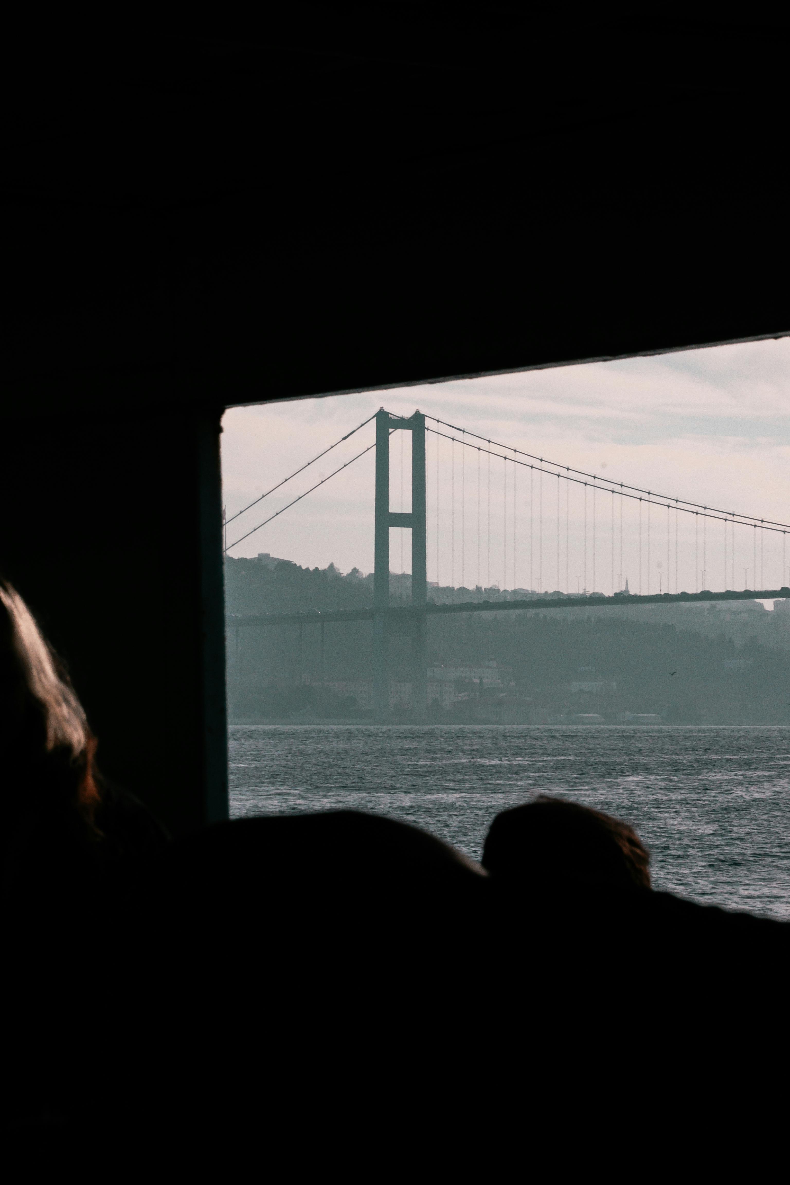Silhouette View of Bridge from Window Frame · Free Stock Photo