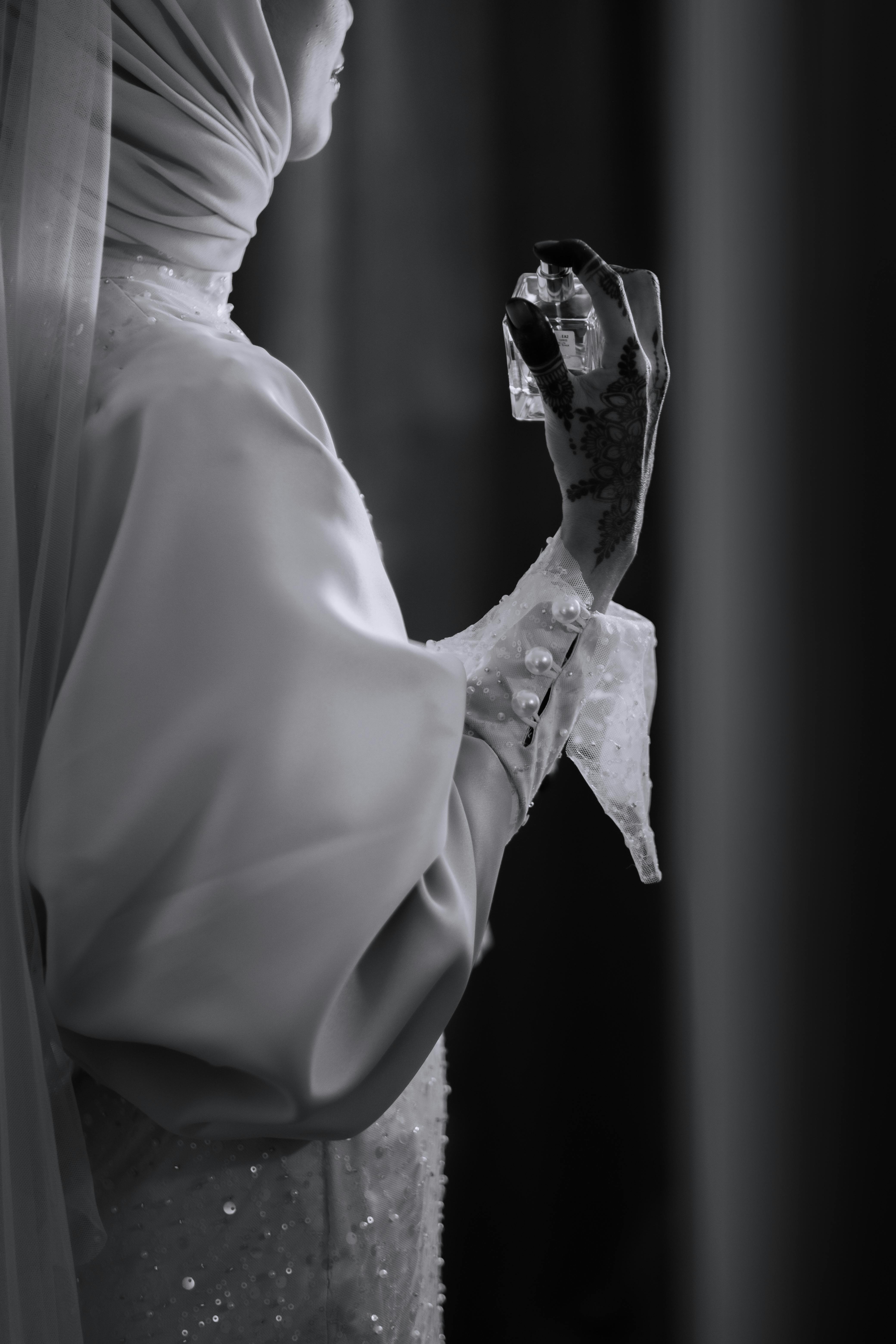 Elegant Woman with Intricate Henna Design Holding Perfume · Free Stock ...