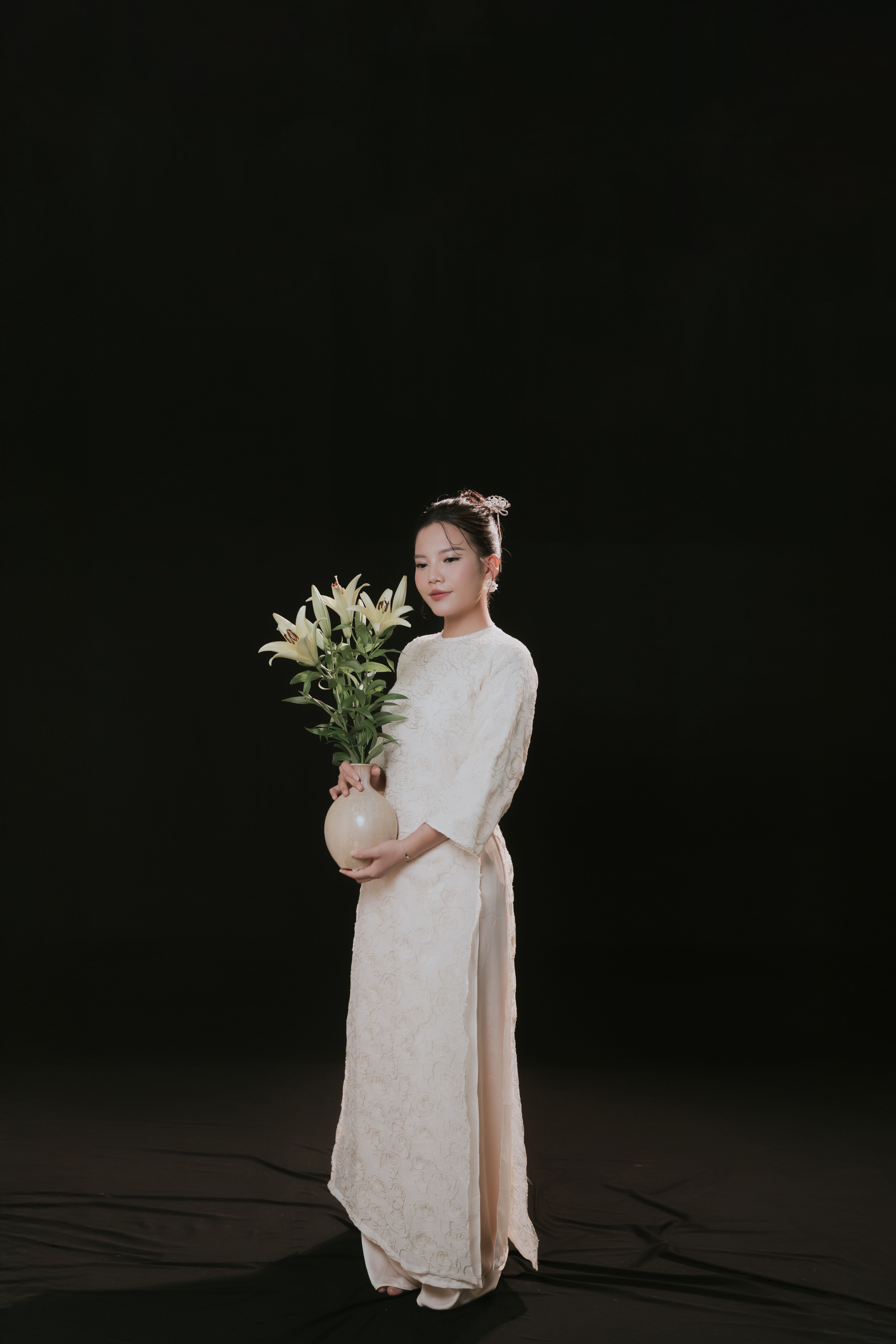 Elegant Woman in Traditional Dress Holding Lilies · Free Stock Photo