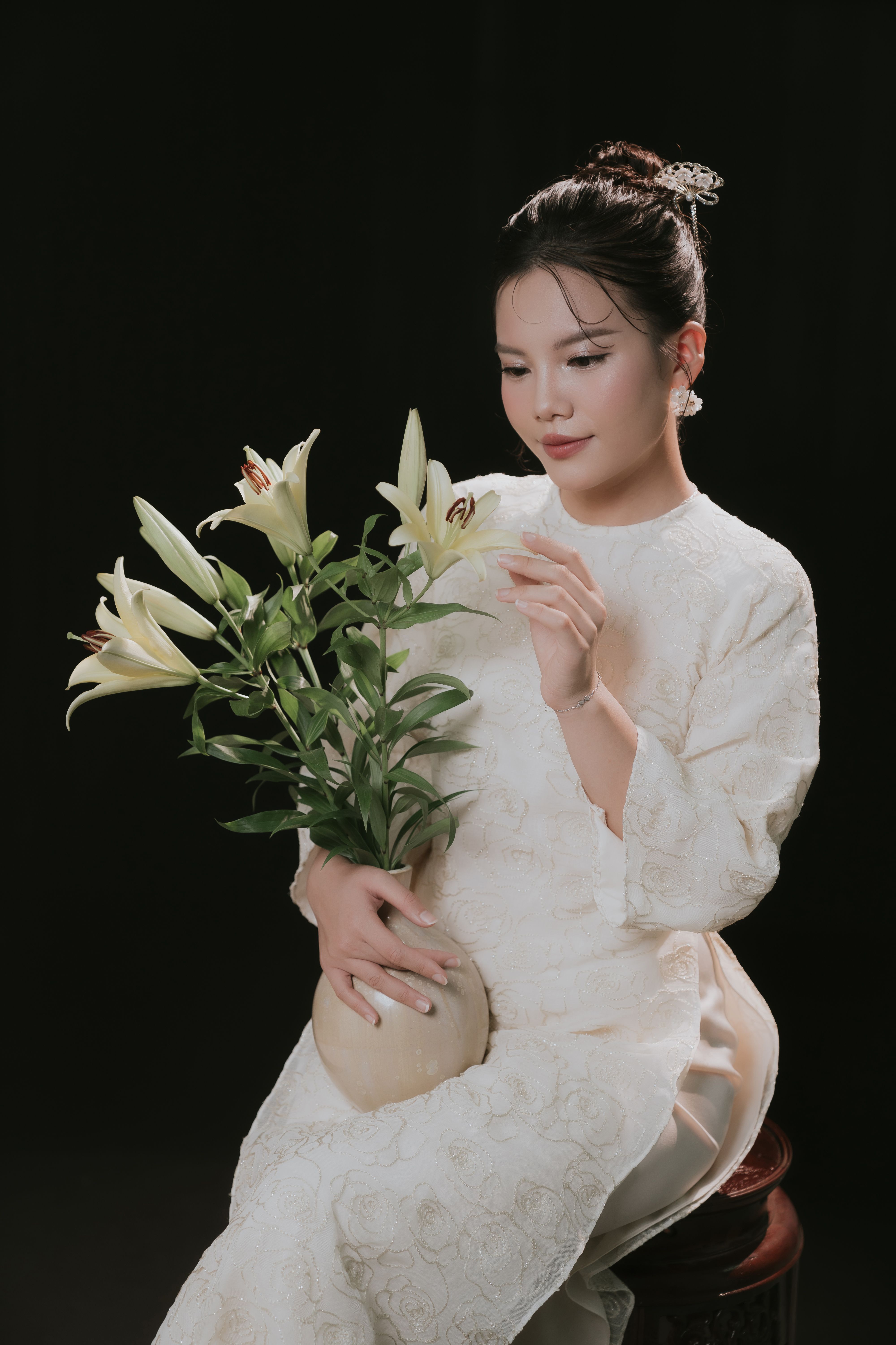 Elegant Woman in Traditional Dress Holding Lilies · Free Stock Photo