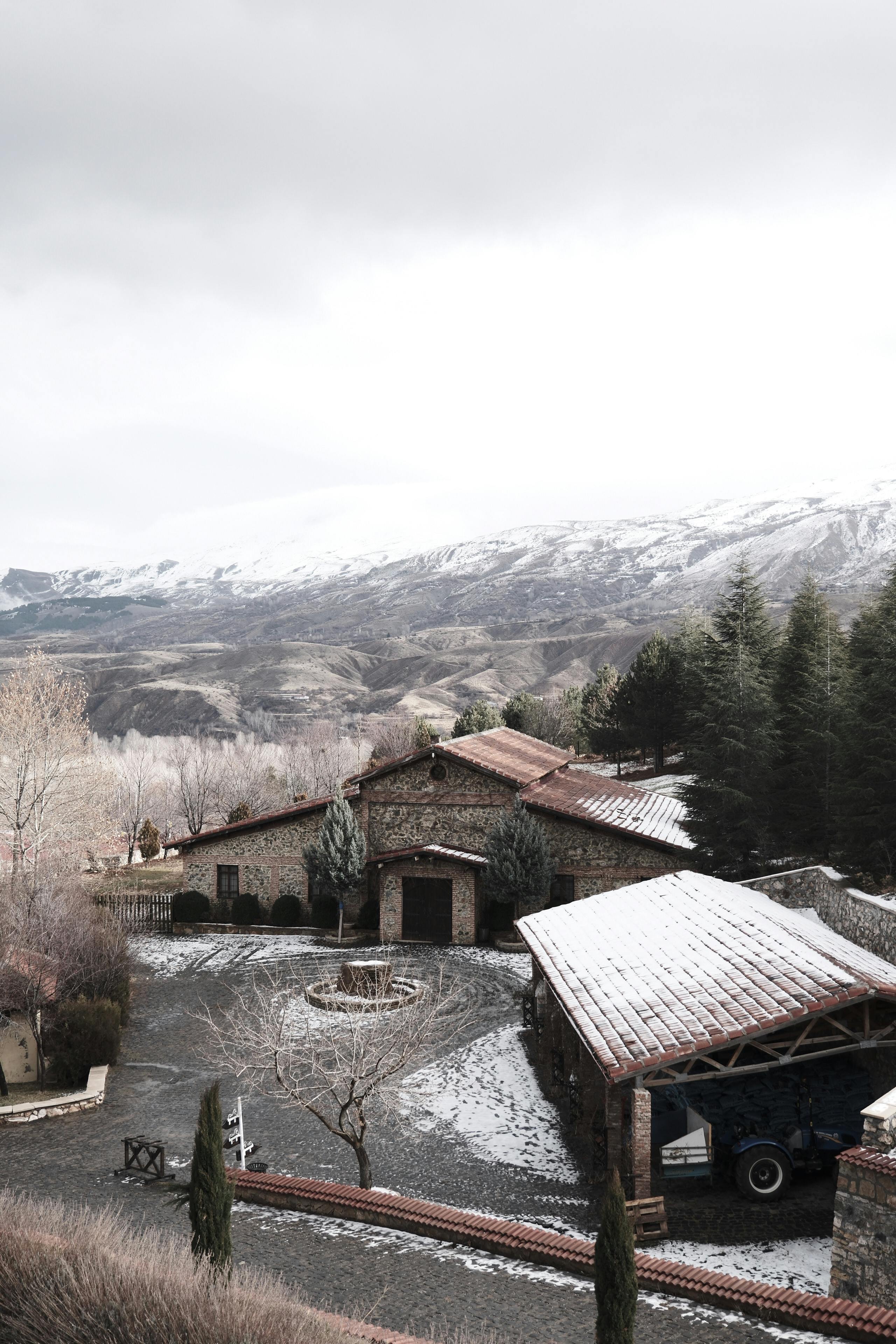 Rustic snow-covered villa in serene mountain landscape · Free Stock Photo