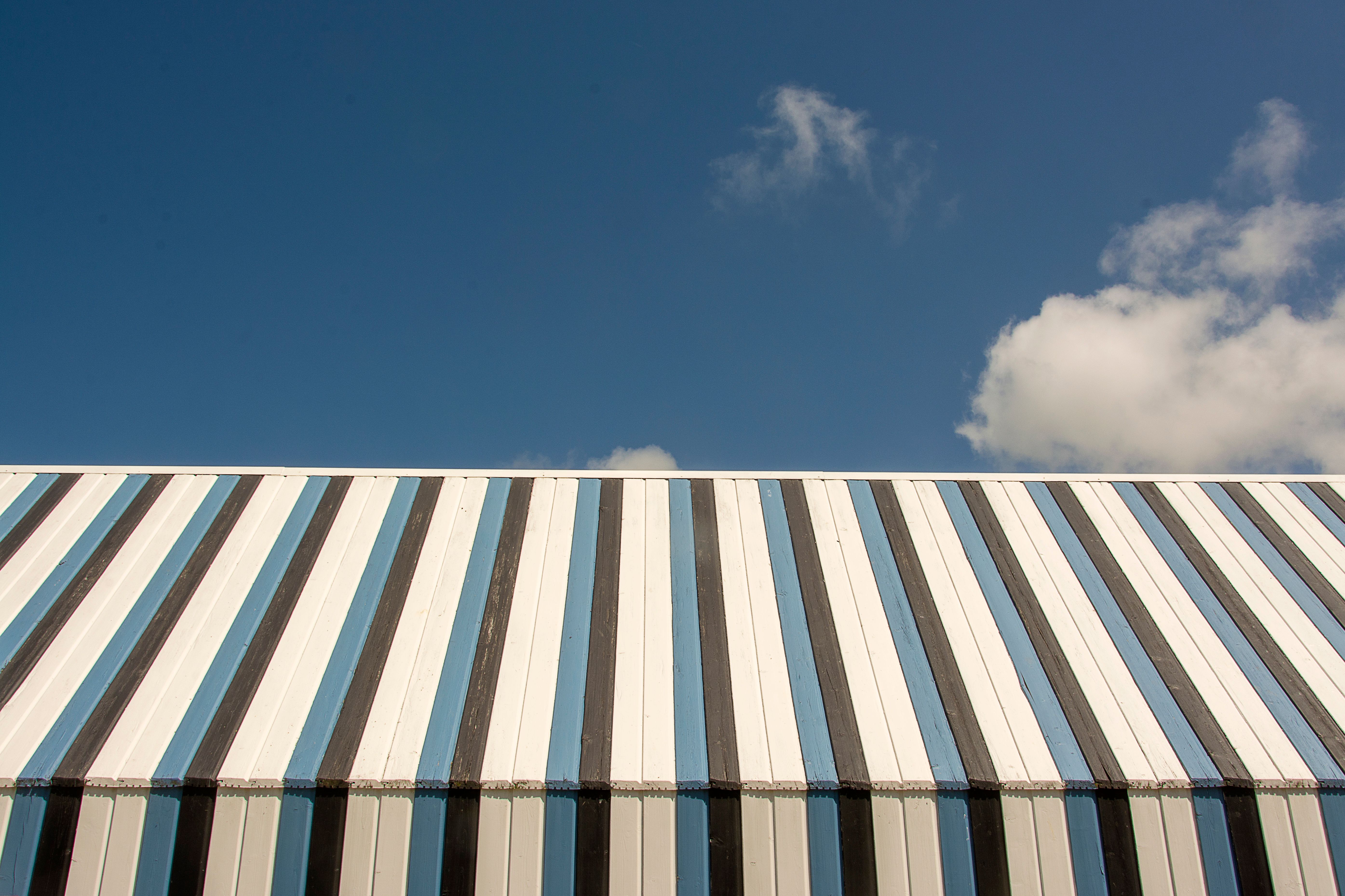 Striped Roof Against a Clear Blue Sky · Free Stock Photo