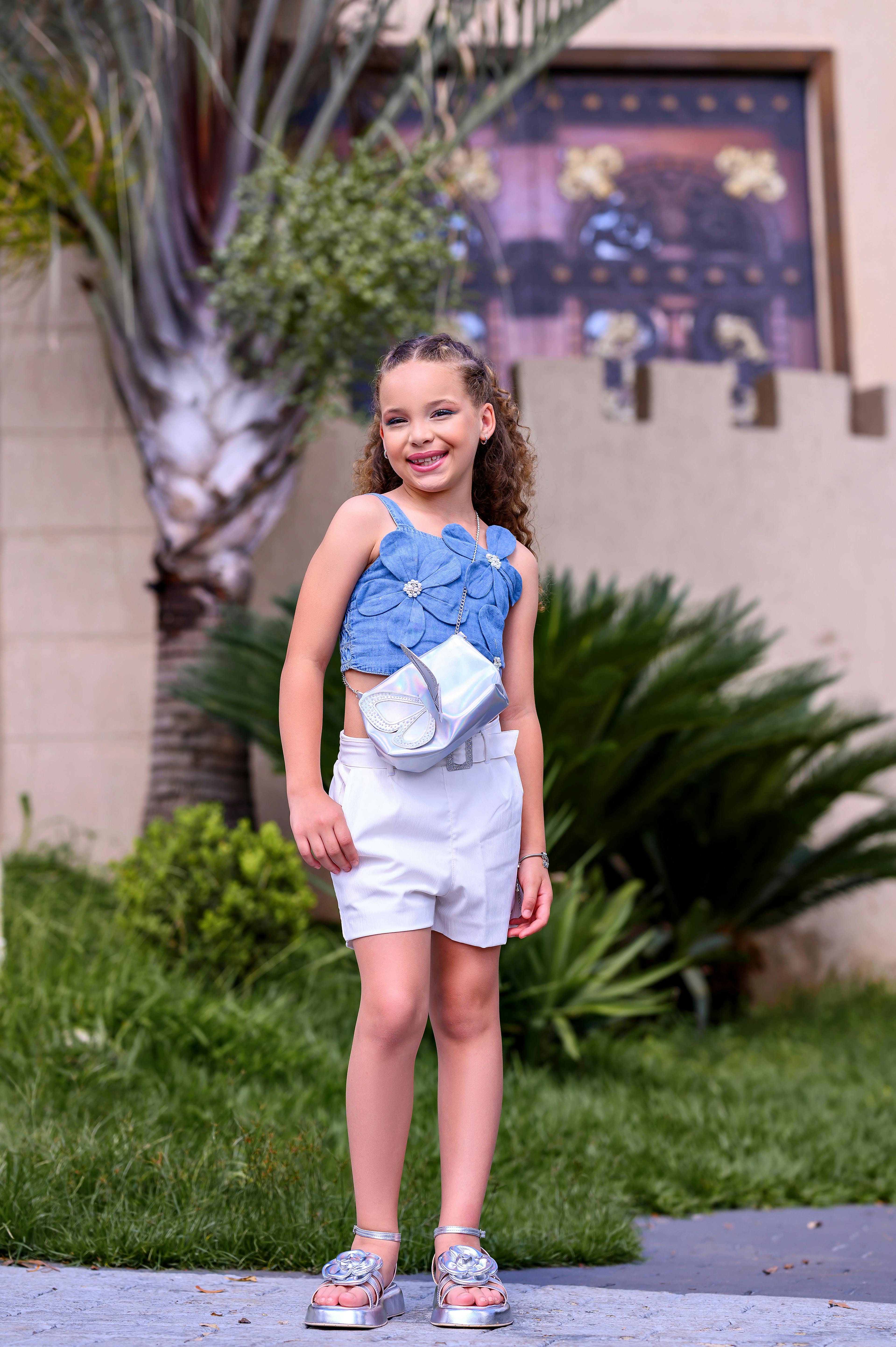 Young Girl Posing Outdoors in Summer Fashion · Free Stock Photo