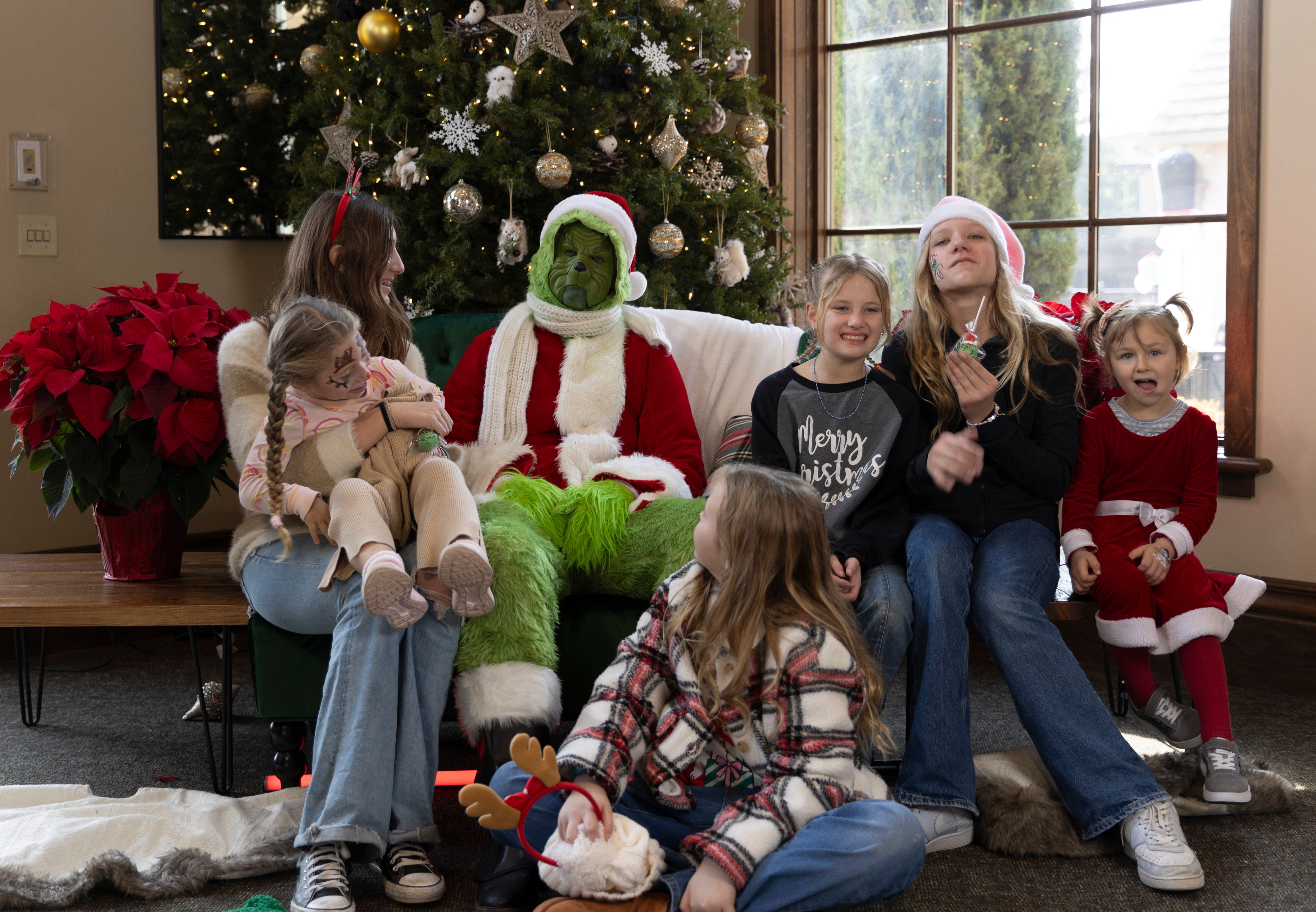 Family Celebrating Christmas with Grinch Character · Free Stock Photo