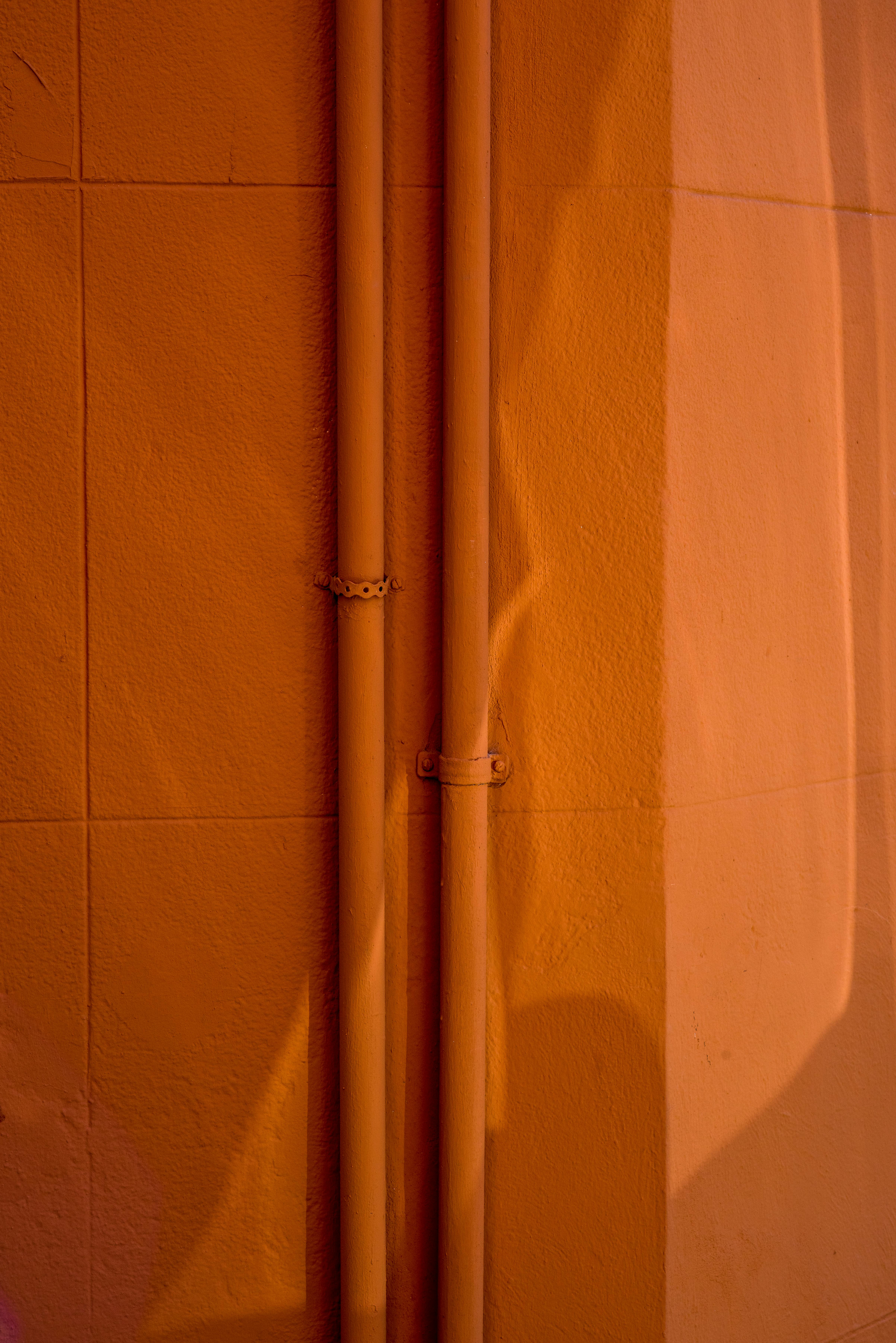 Abstract Urban Wall with Vertical Pipes · Free Stock Photo