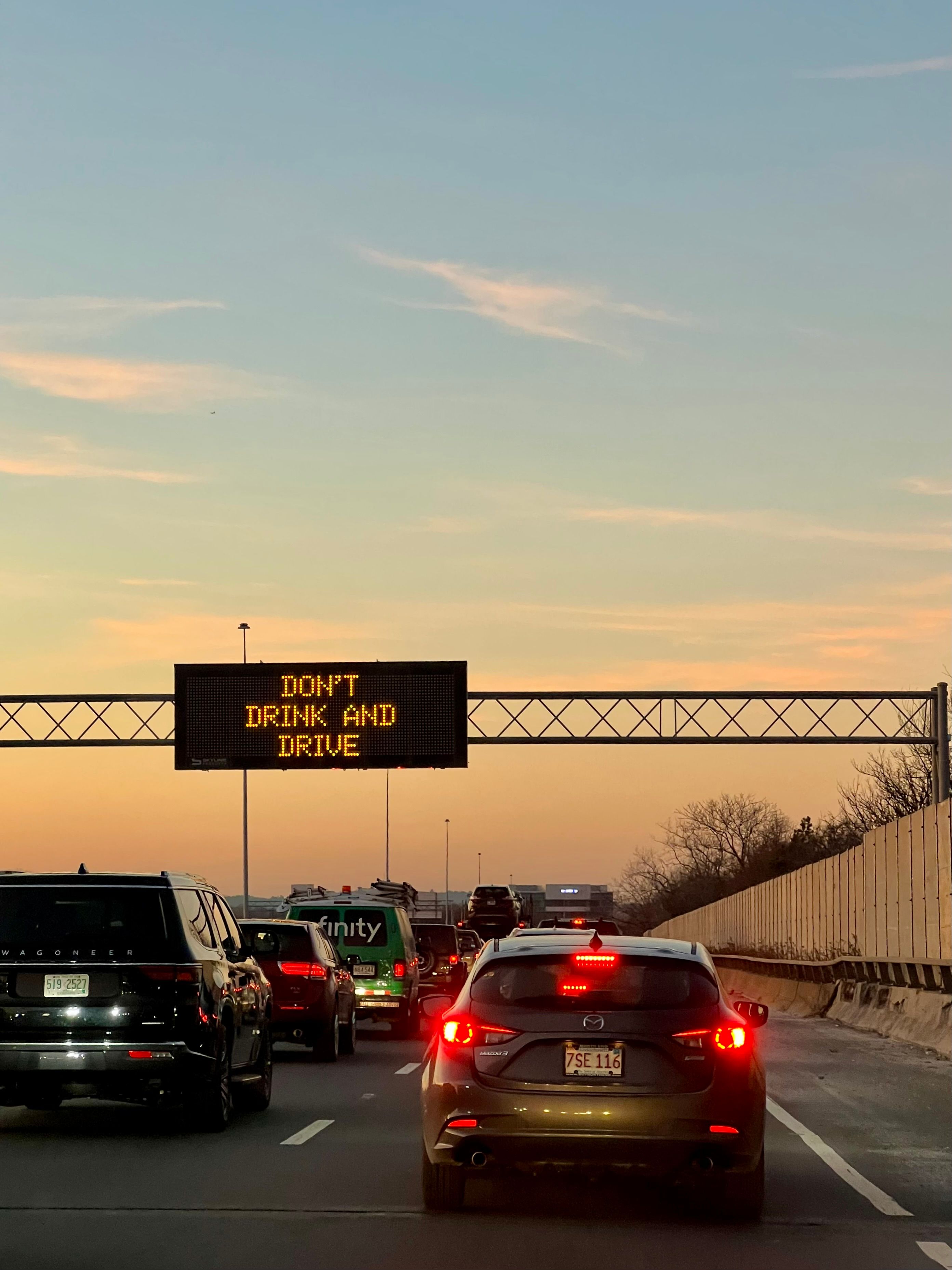 Traffic Jam with Road Safety Warning Sign at Sunset · Free Stock Photo